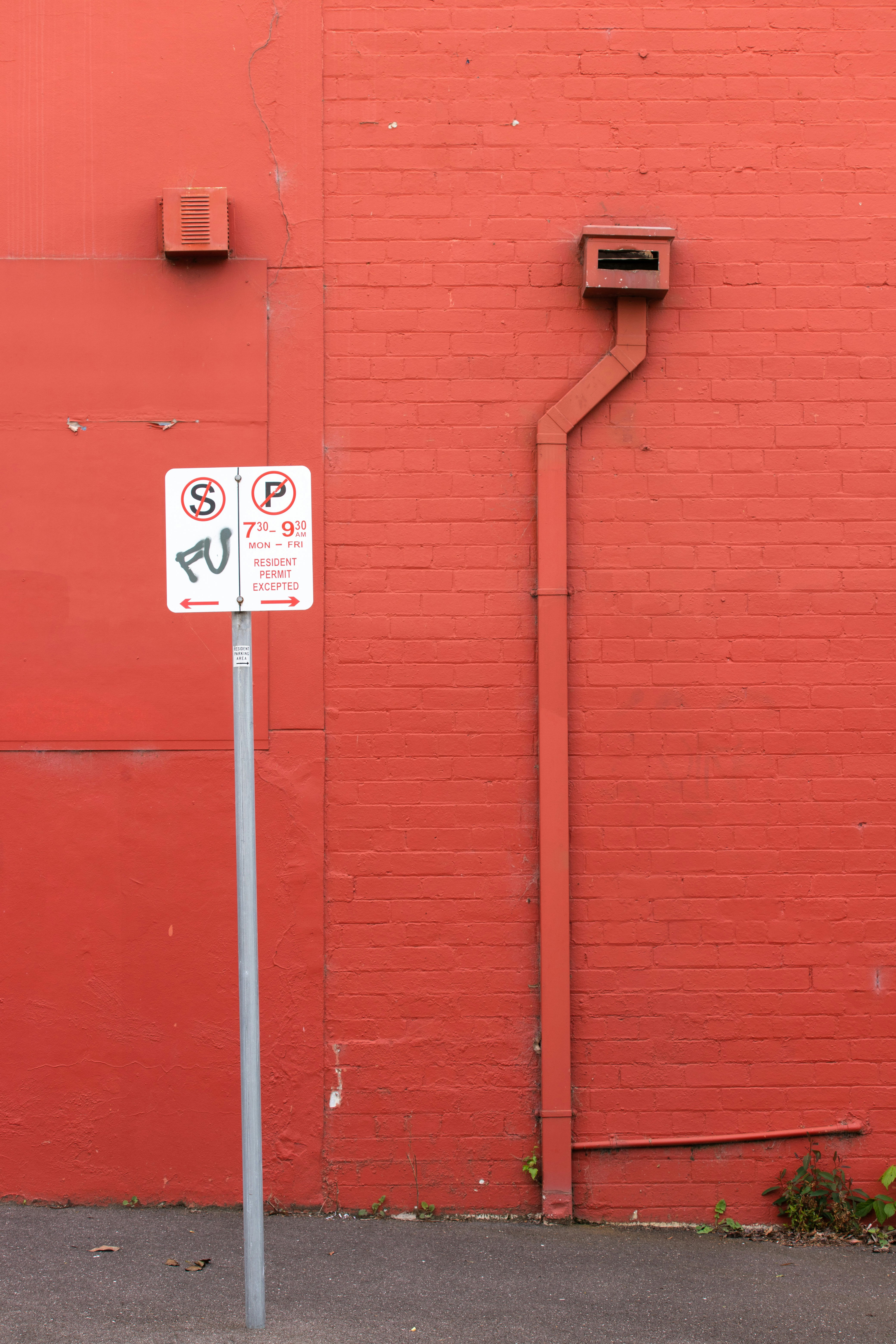 no smoking sign on red wall