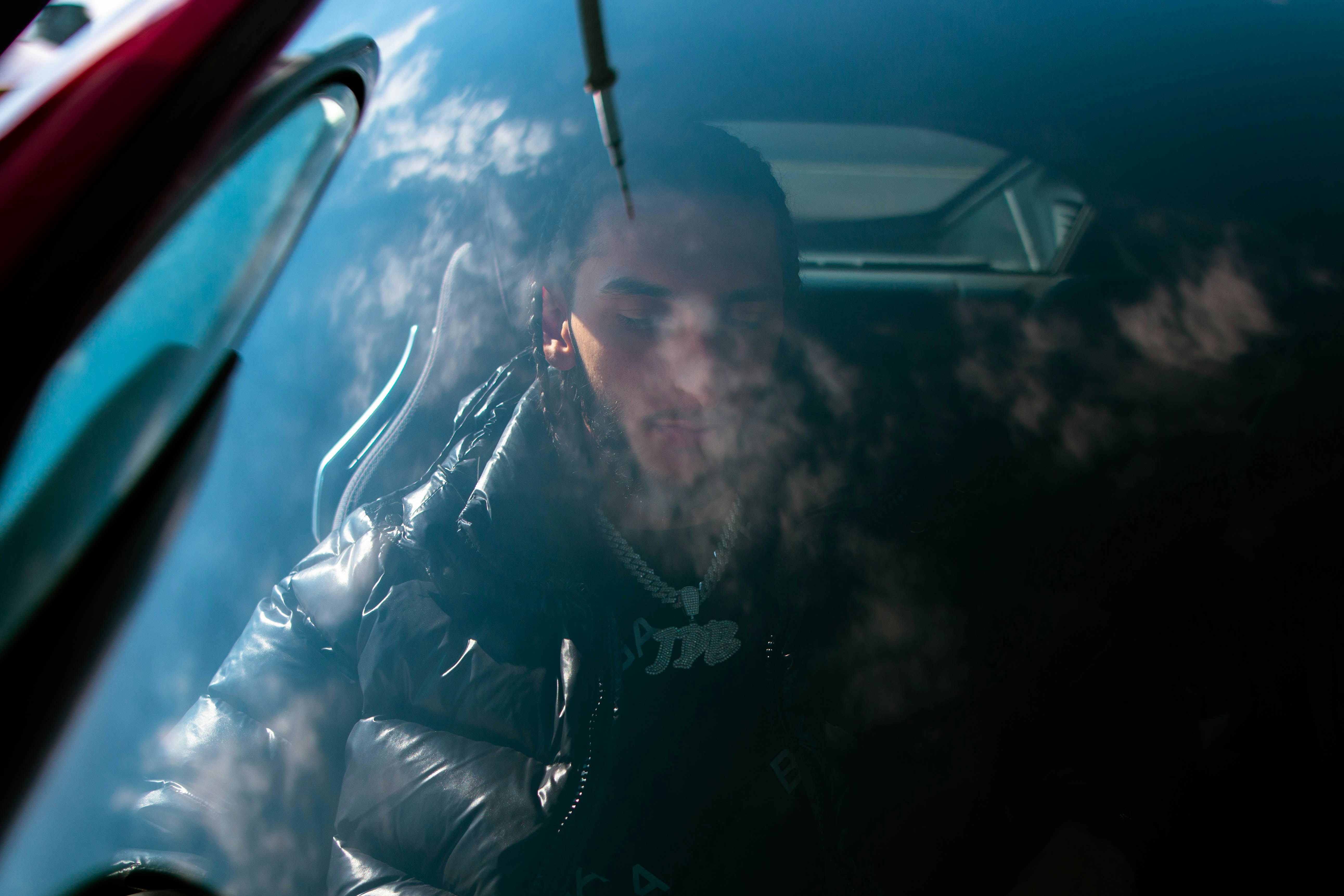 Reflection in the Glass: A Quiet Portrait Behind Car Window