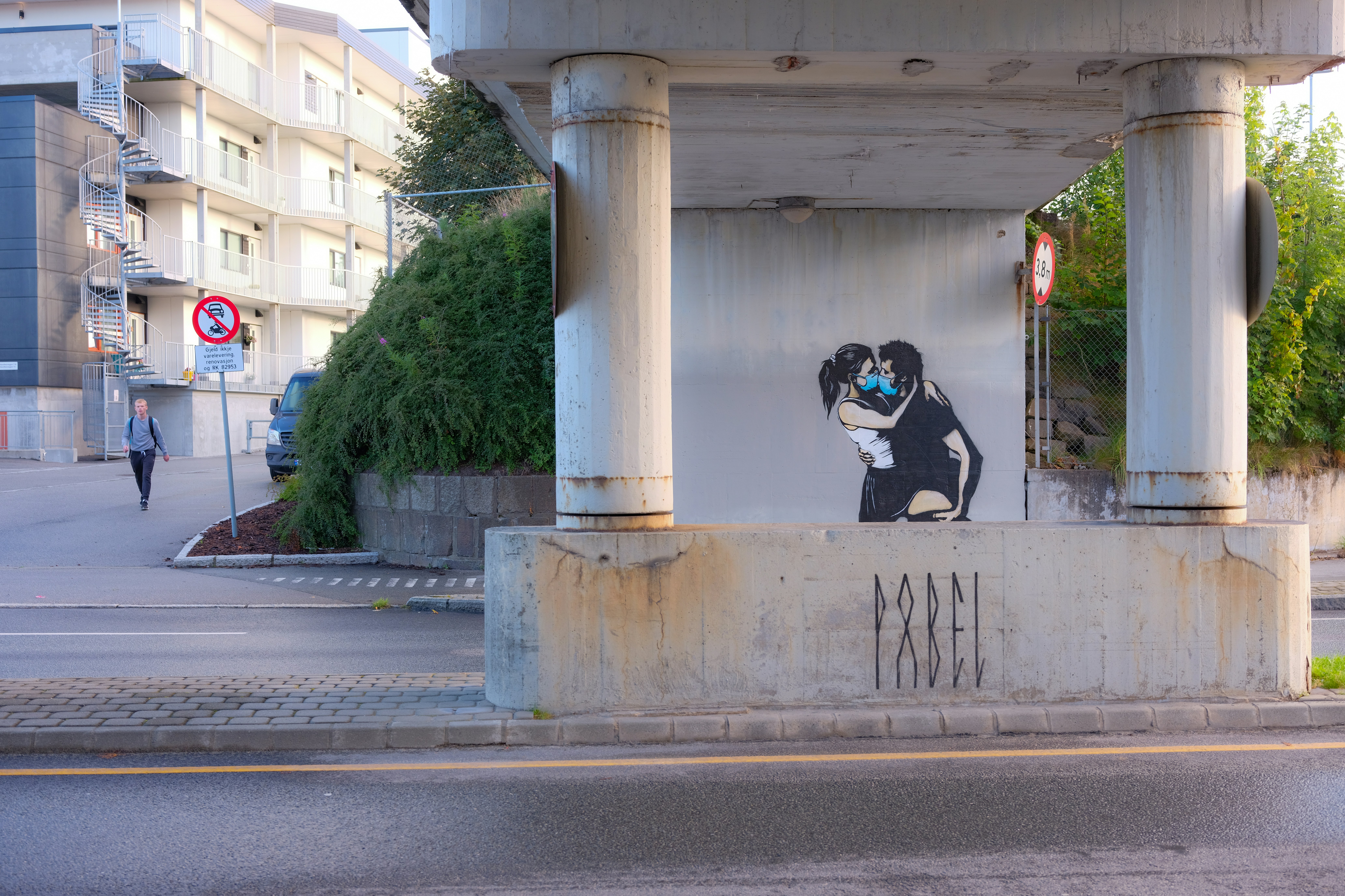Under the Concrete Arches: A Graffiti Kiss Framed by Columns