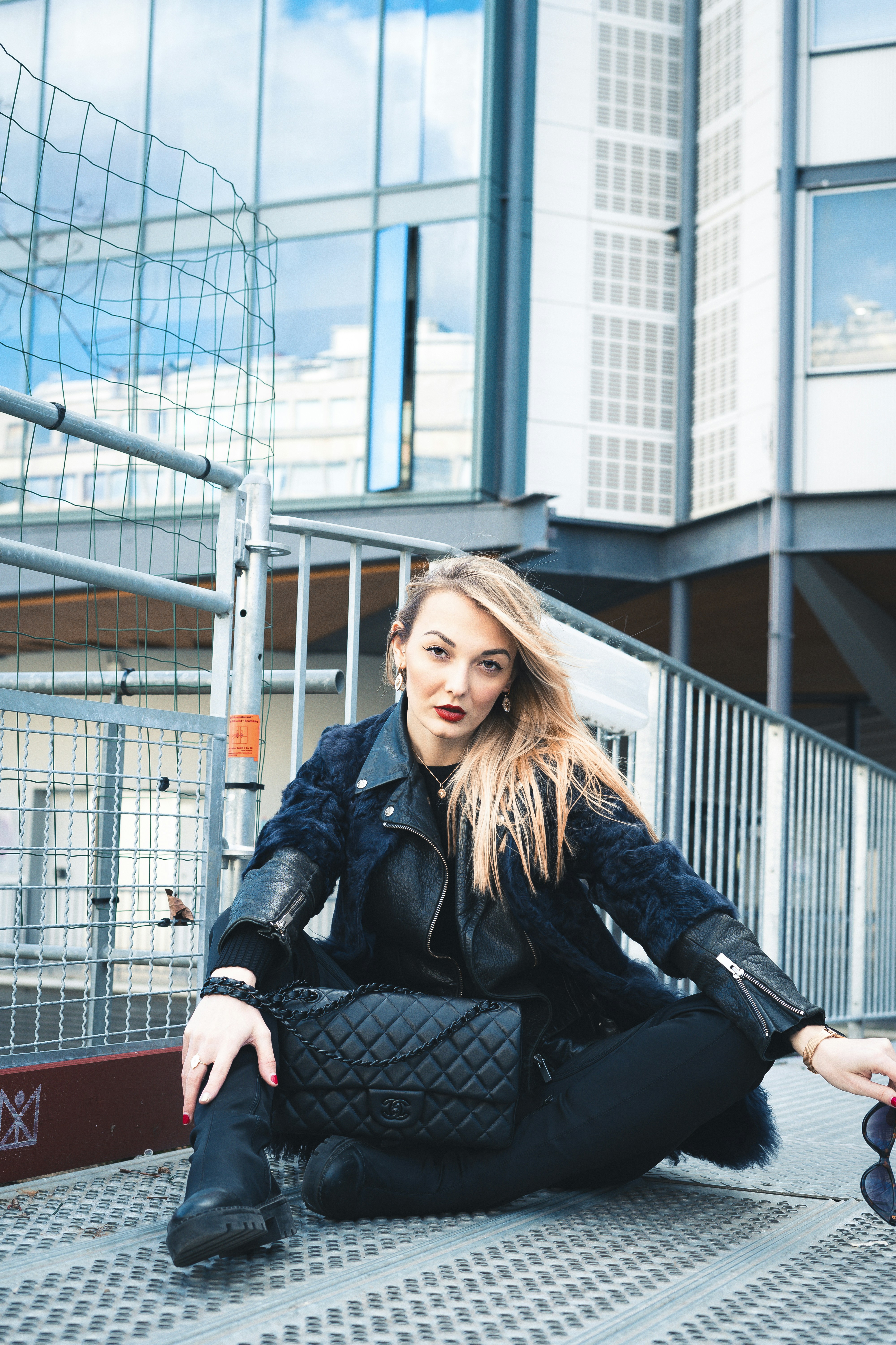 Urban Portrait on Metallic Stage: Leather, Glass, and Quiet Confidence