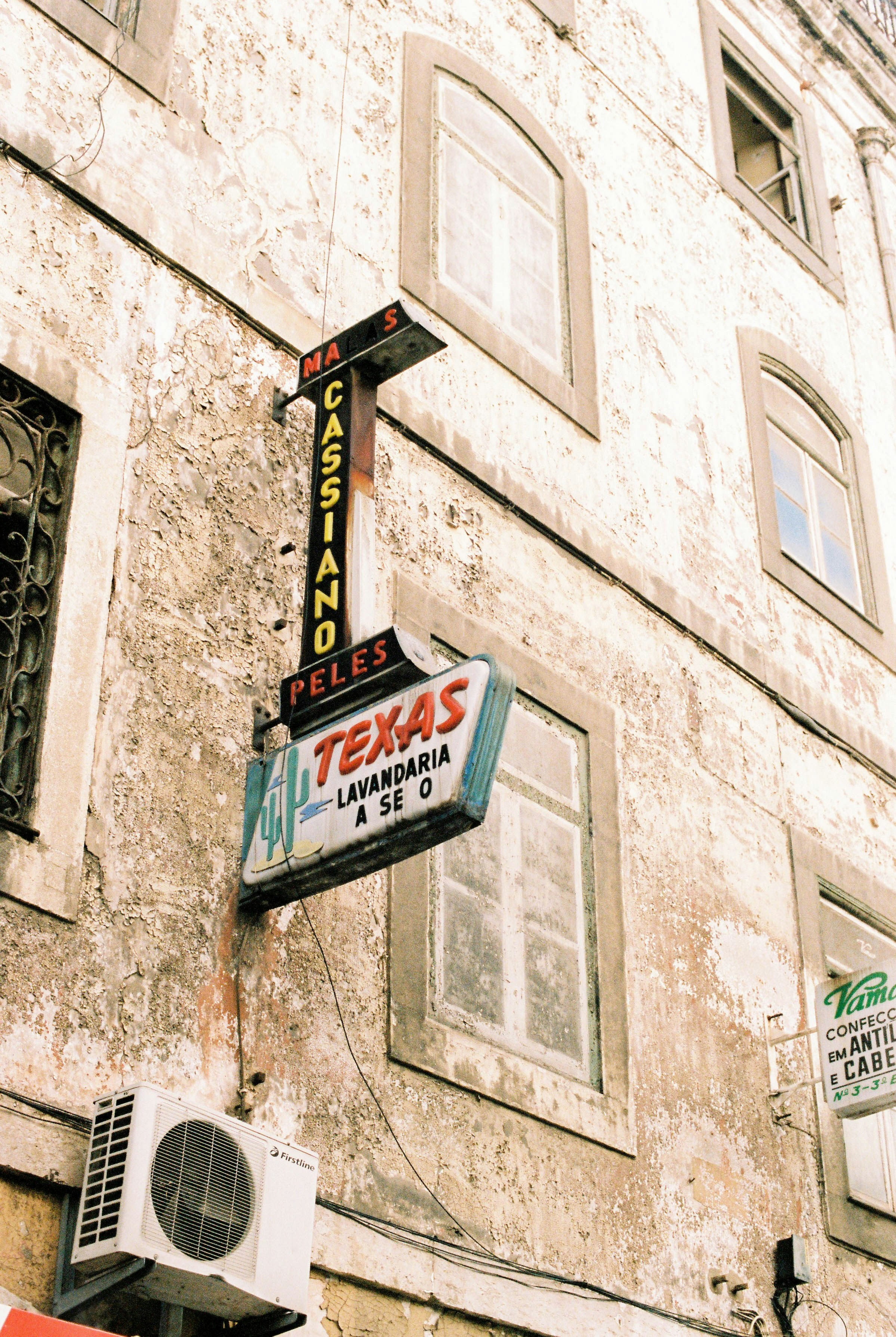 Neon Sign in Weathered Facade: A Dying Texan Luminosity