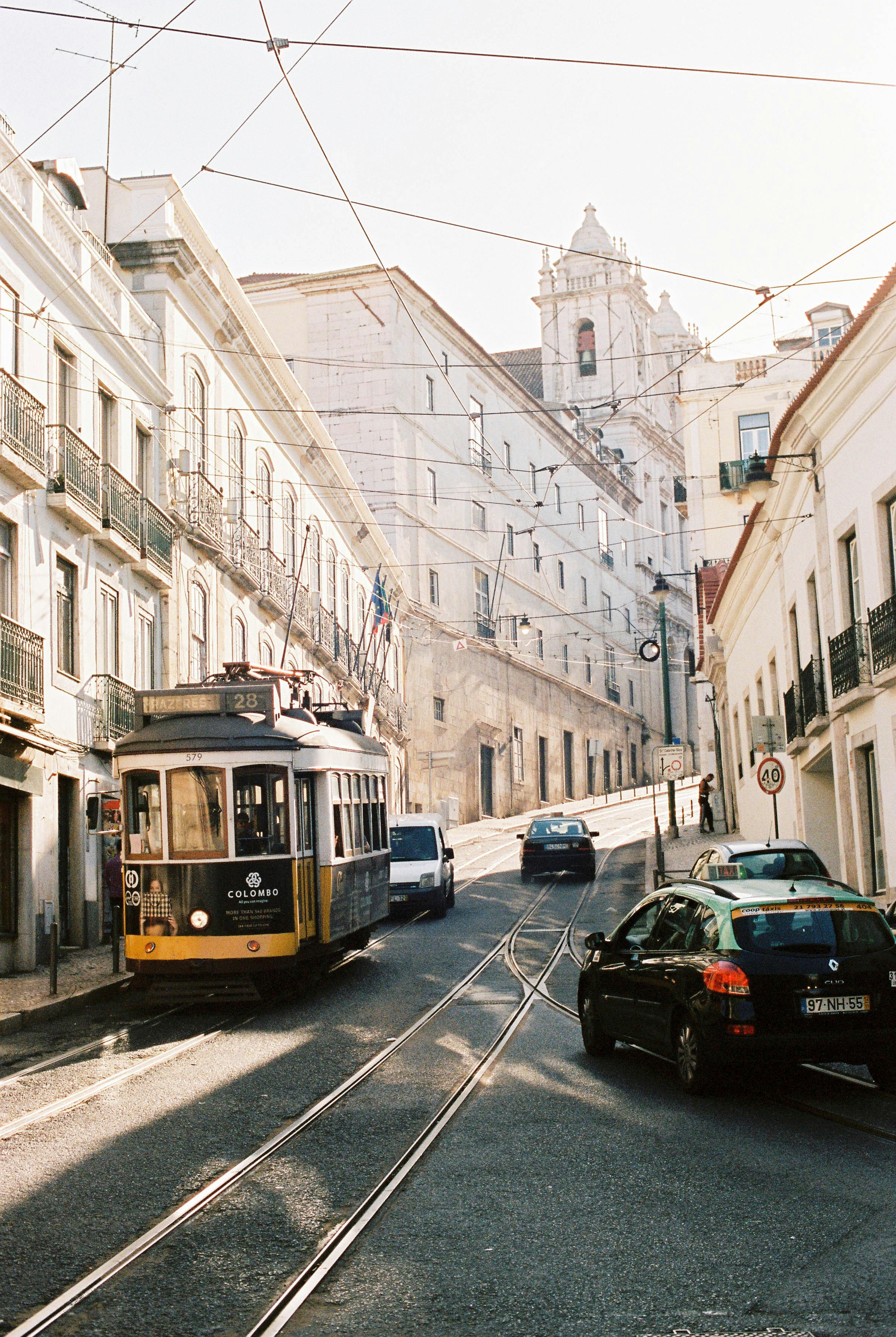 Lisbon's Tram 28 on a Sunlit Alfama Street