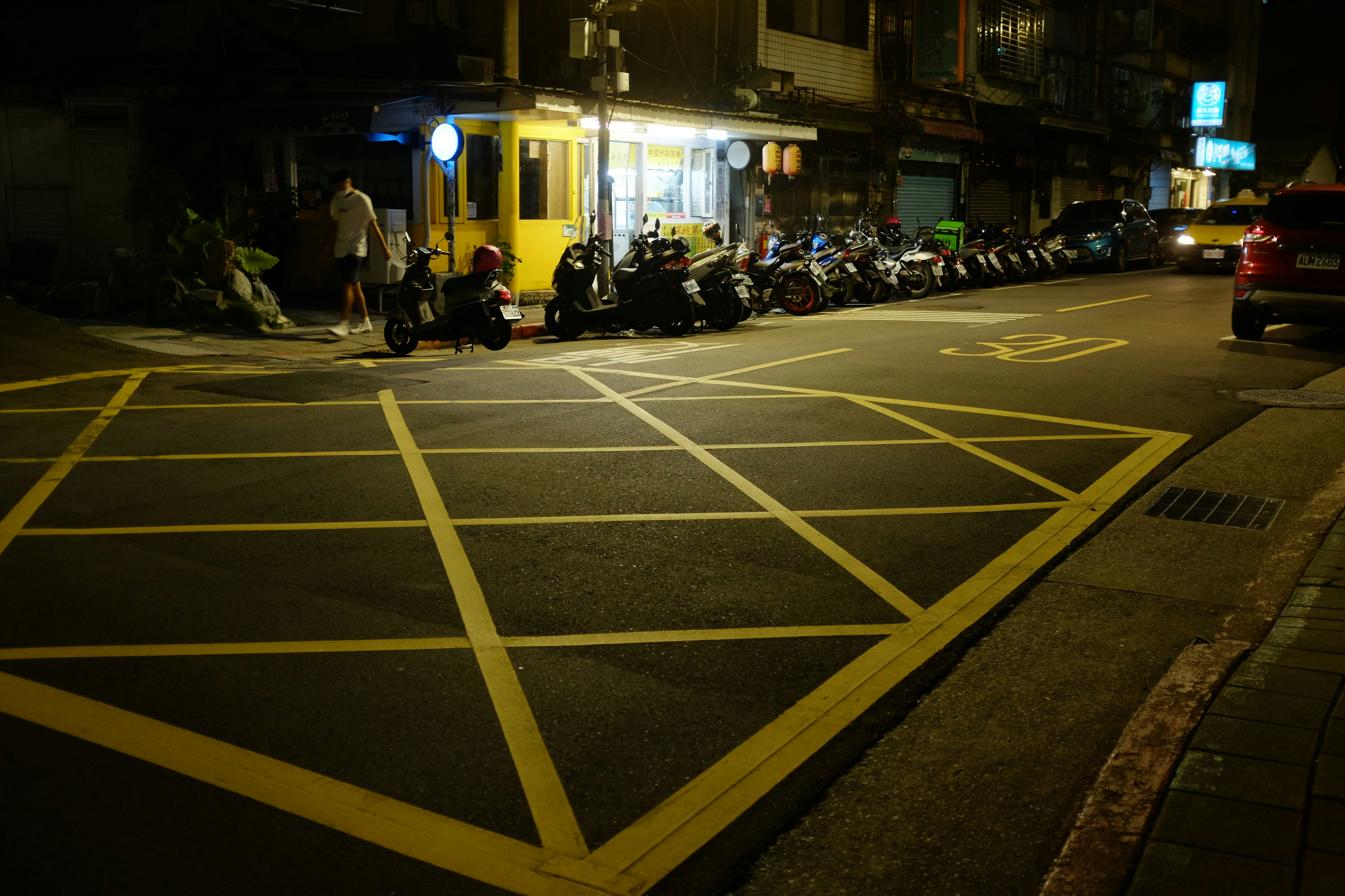 people walking on pedestrian lane during night time