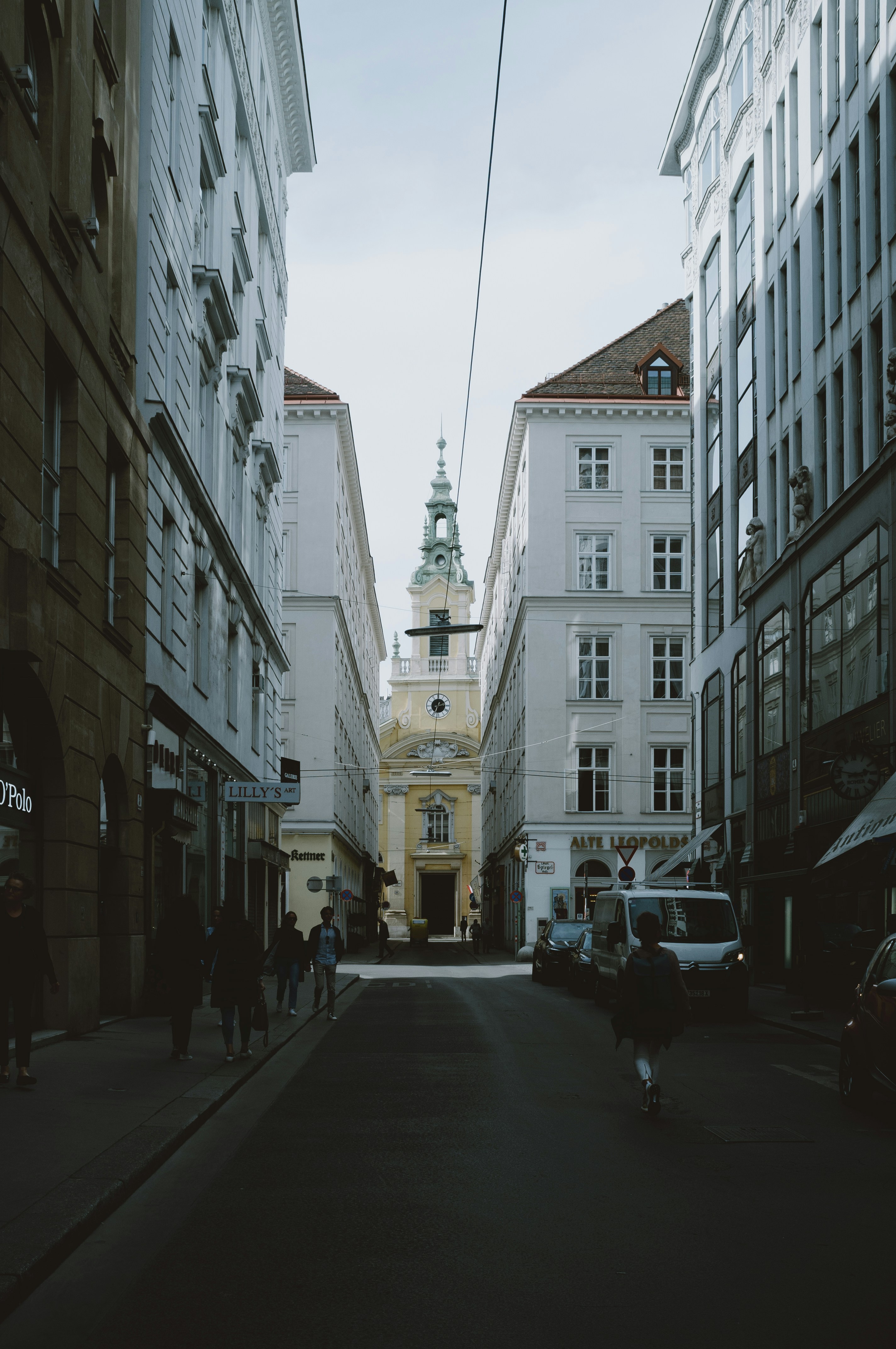 Cars parked on side of the road in between buildings photo – Free Grey ...