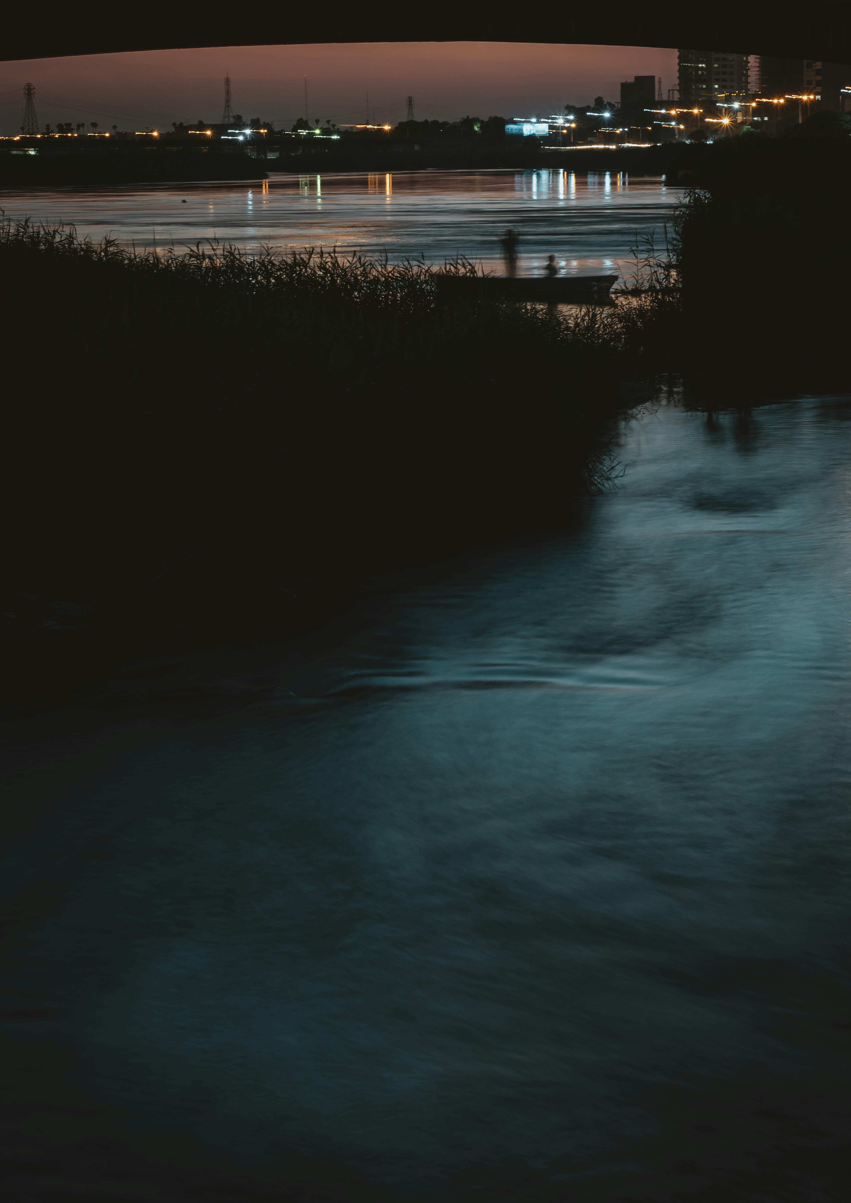 Nocturnal River Silhouette Beneath Neon Horizons