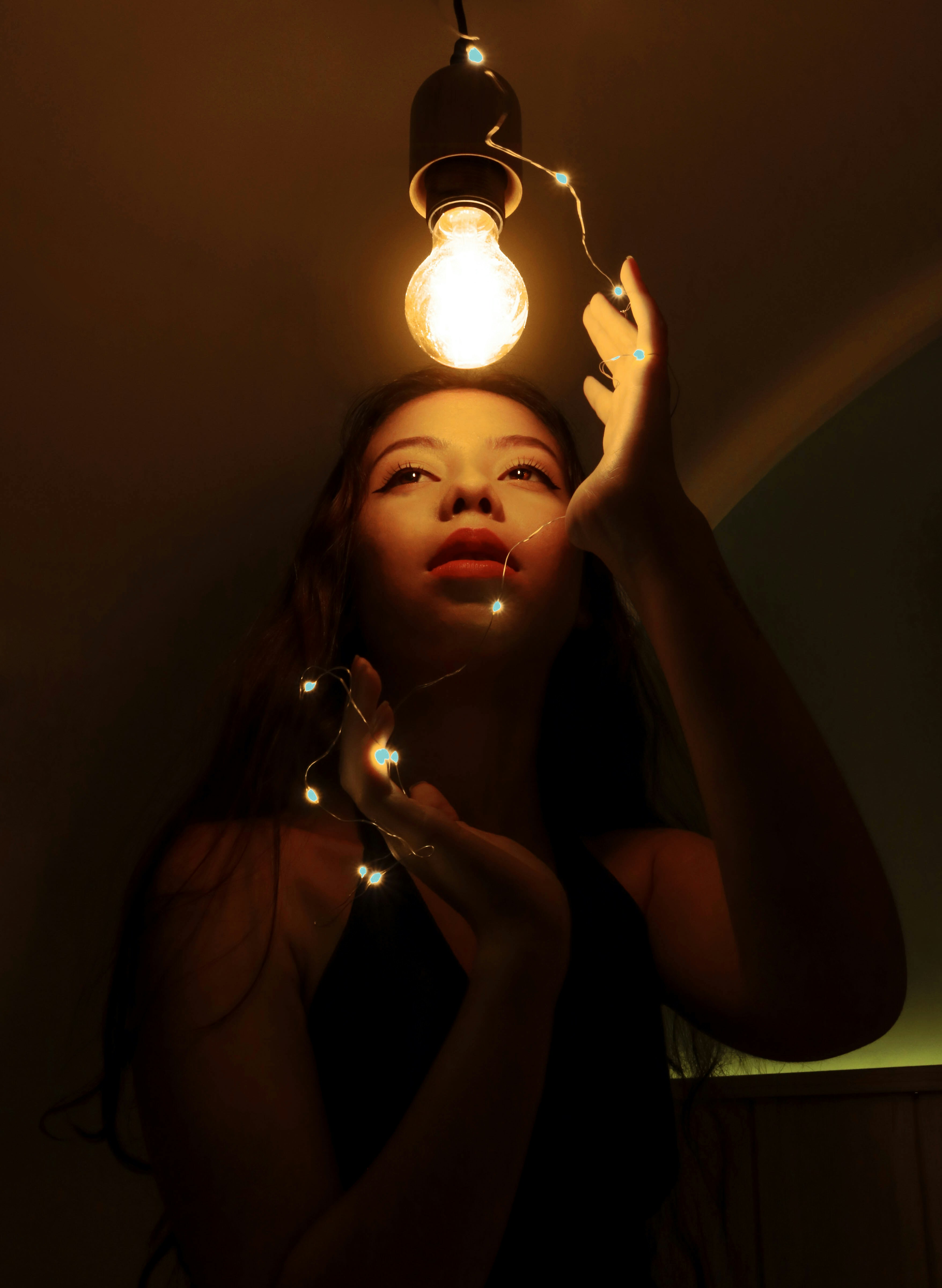 Woman holding lighted string lights photo – Free Black Image on Unsplash