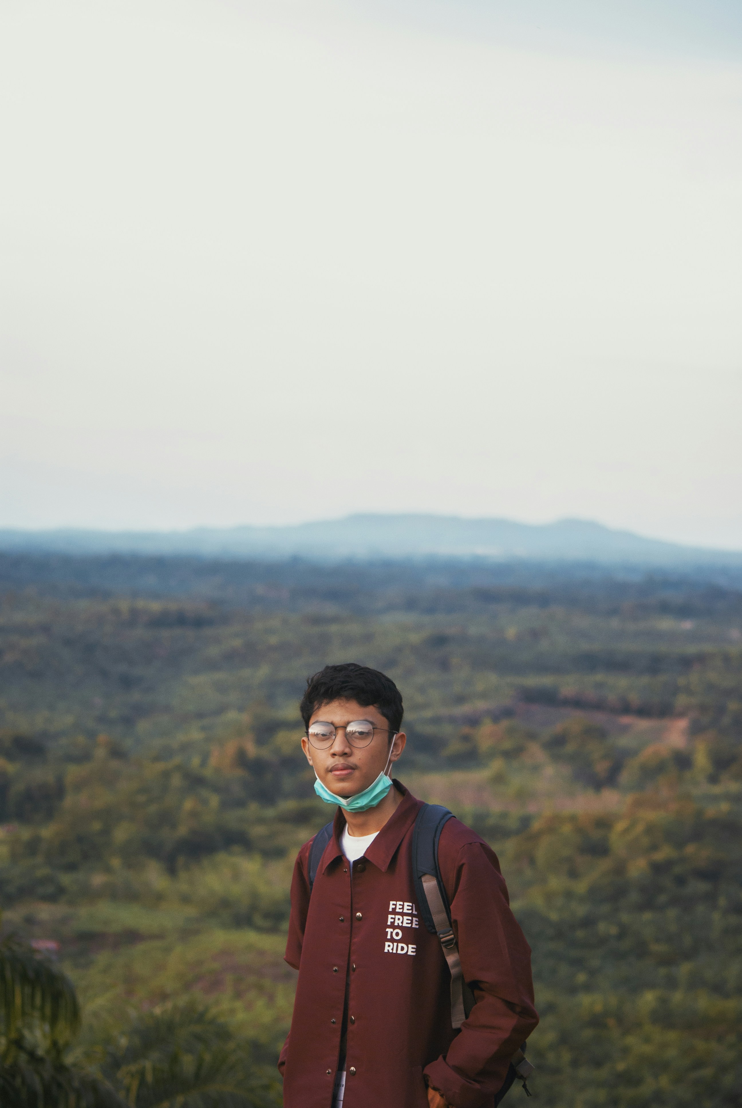 Man in red jacket standing on hill during daytime photo – Free ...