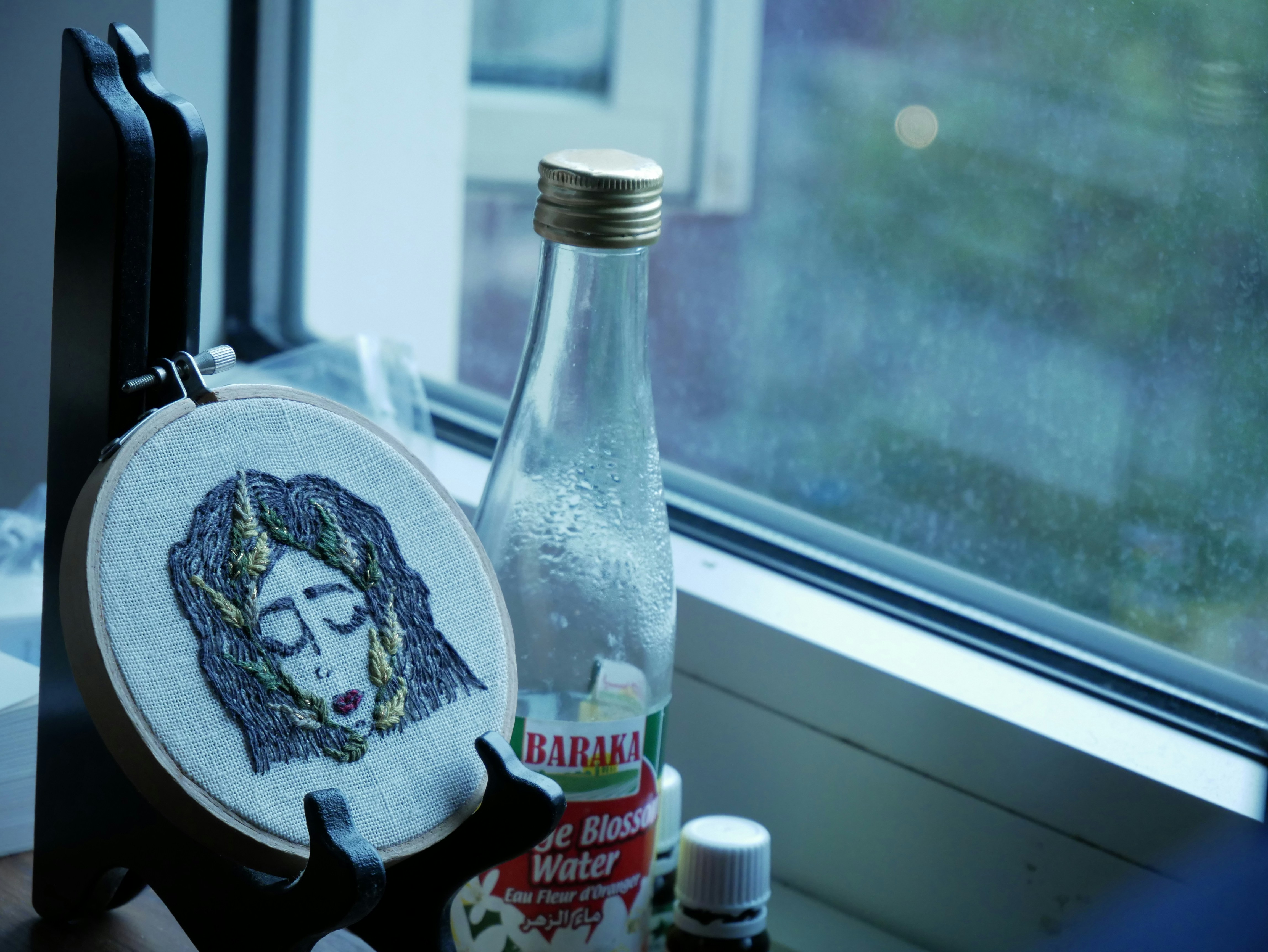 clear glass bottle beside black and white bag