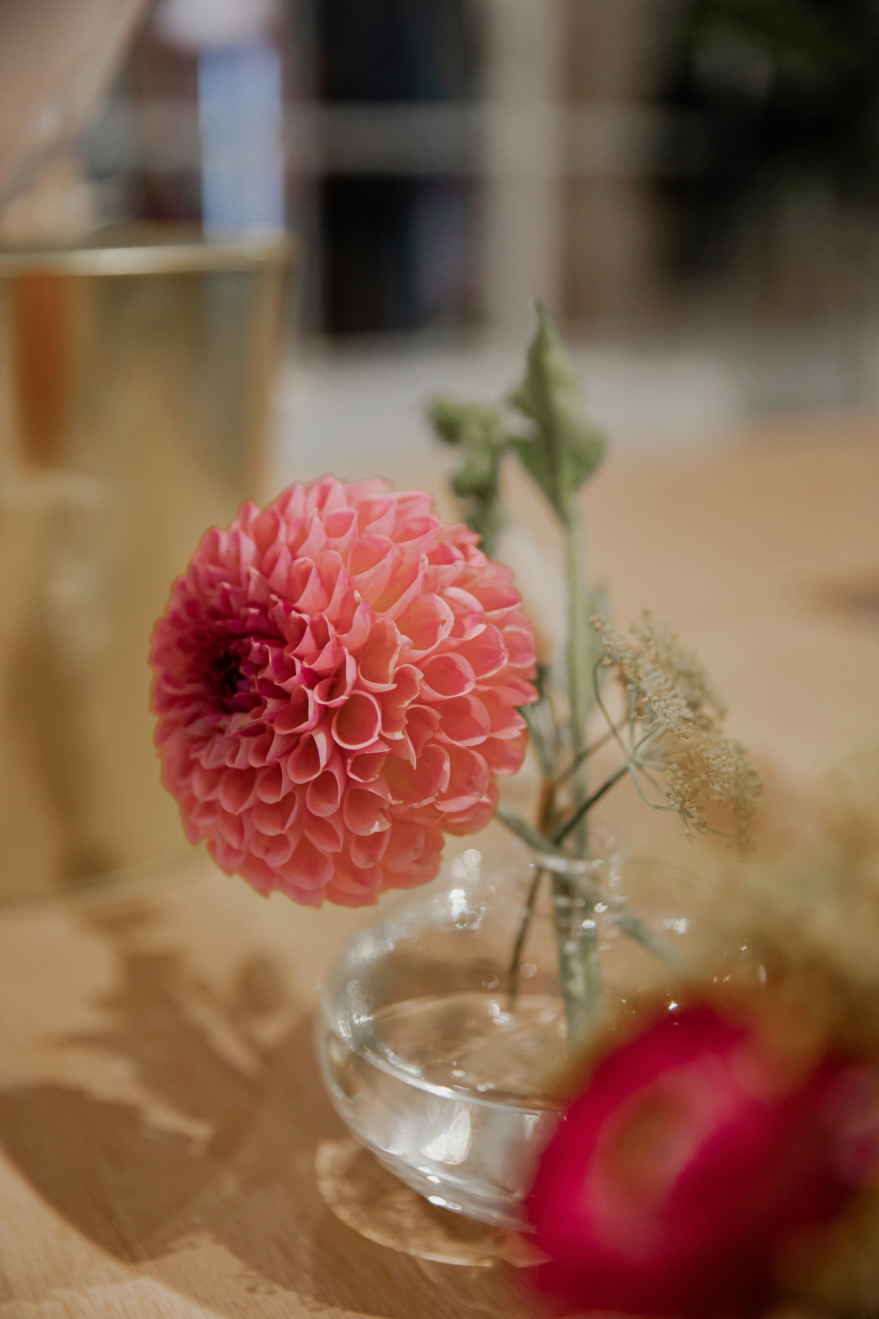Pink Dahlia centerpiece in a delicate glass vase