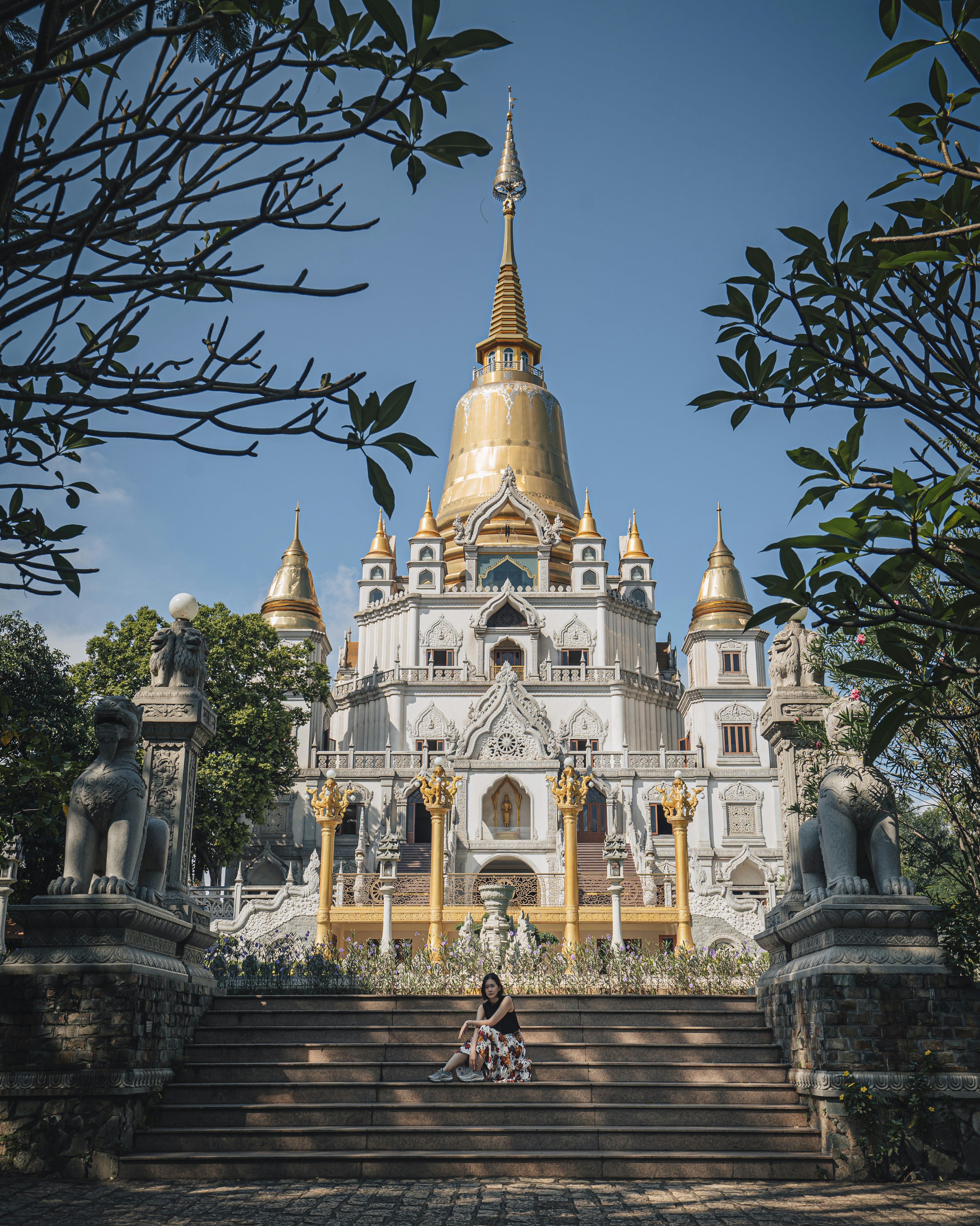 Steps to a Radiant Spire: A Solitary Moment Before the Gilded Sanctuary