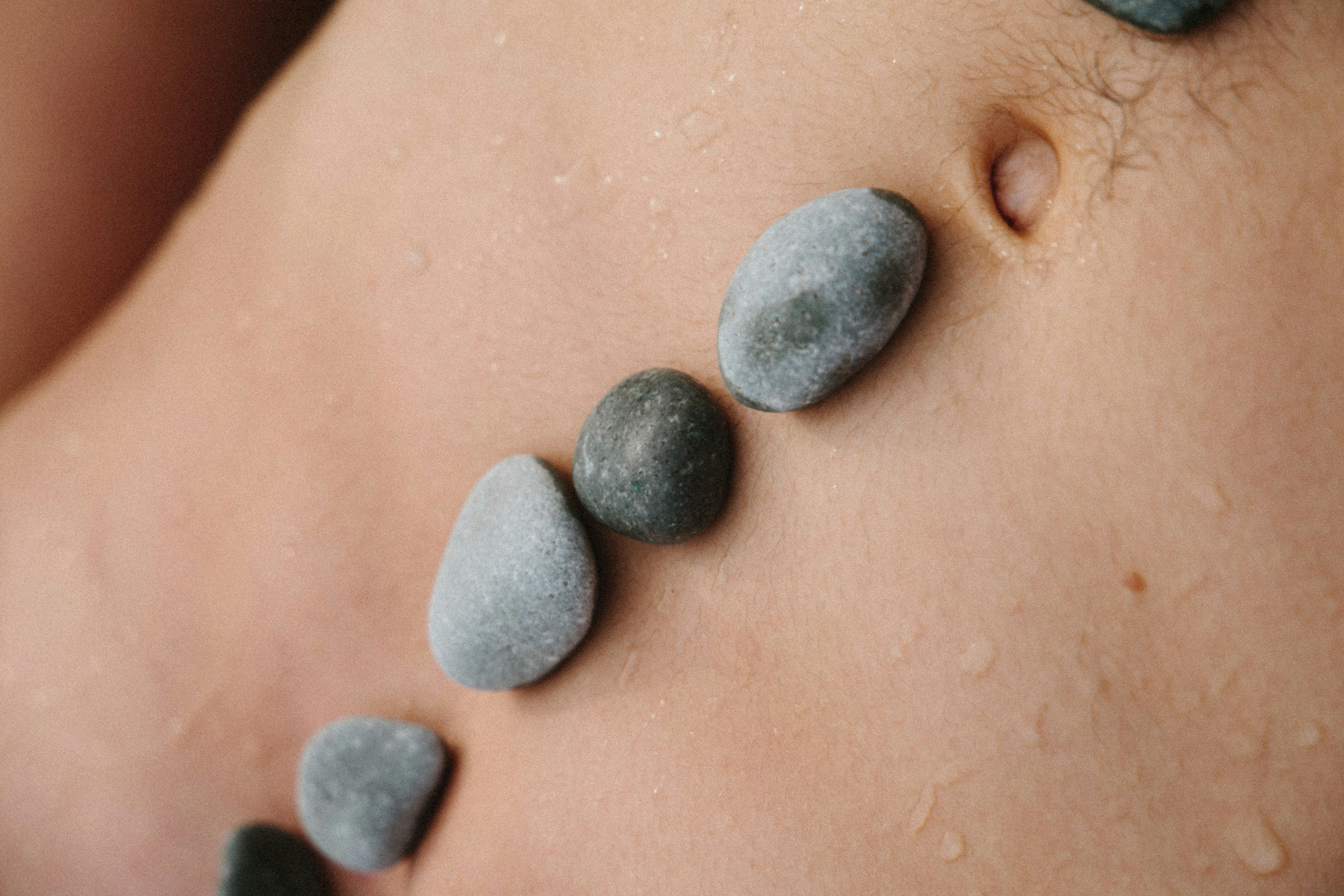 Black stones on human skin photo – Free Pebble Image on Unsplash