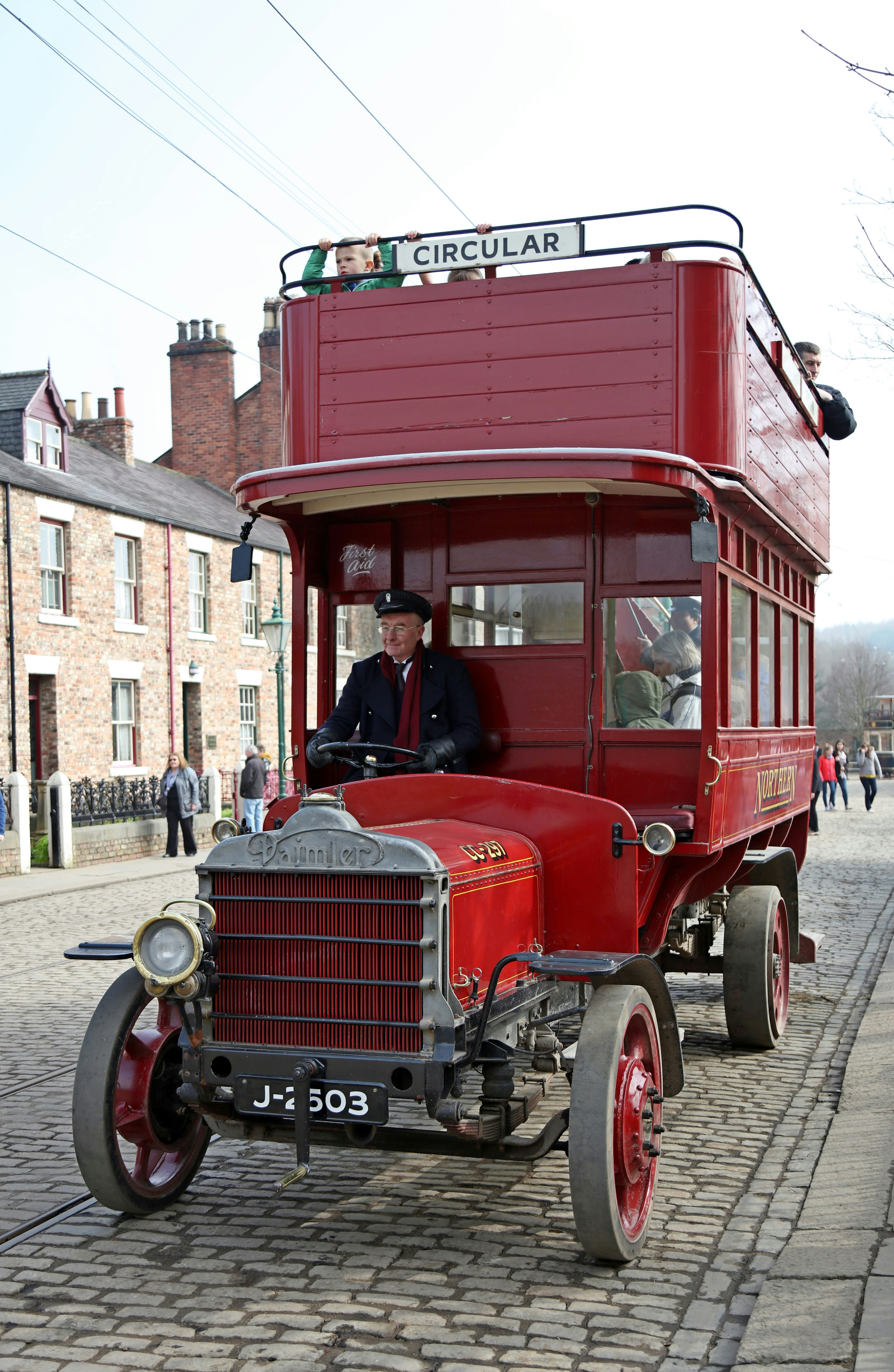 Crimson Vintage Double-Decker on a Cobbled Town Street