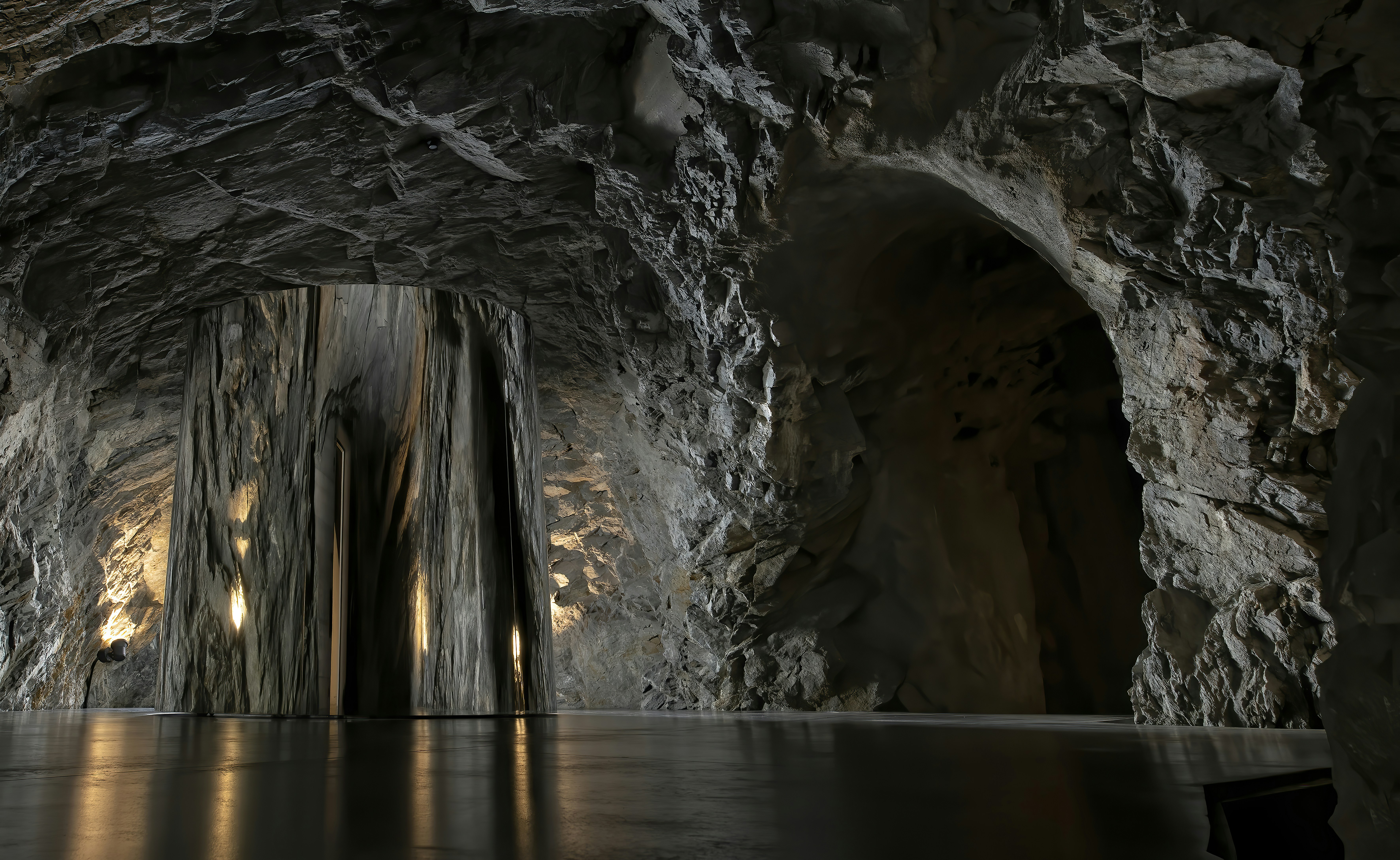 Gray and black cave near body of water photo – Free Susch Image on Unsplash
