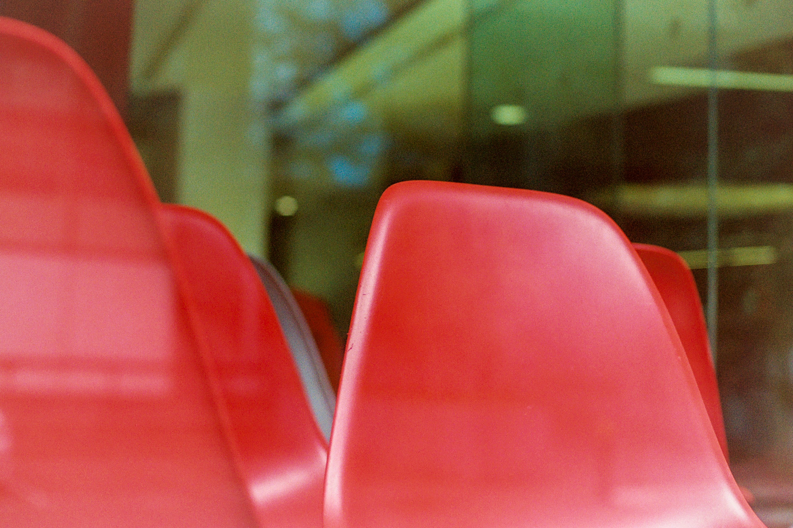 Scarlet Seats in a Quiet Glass-Walled Hall
