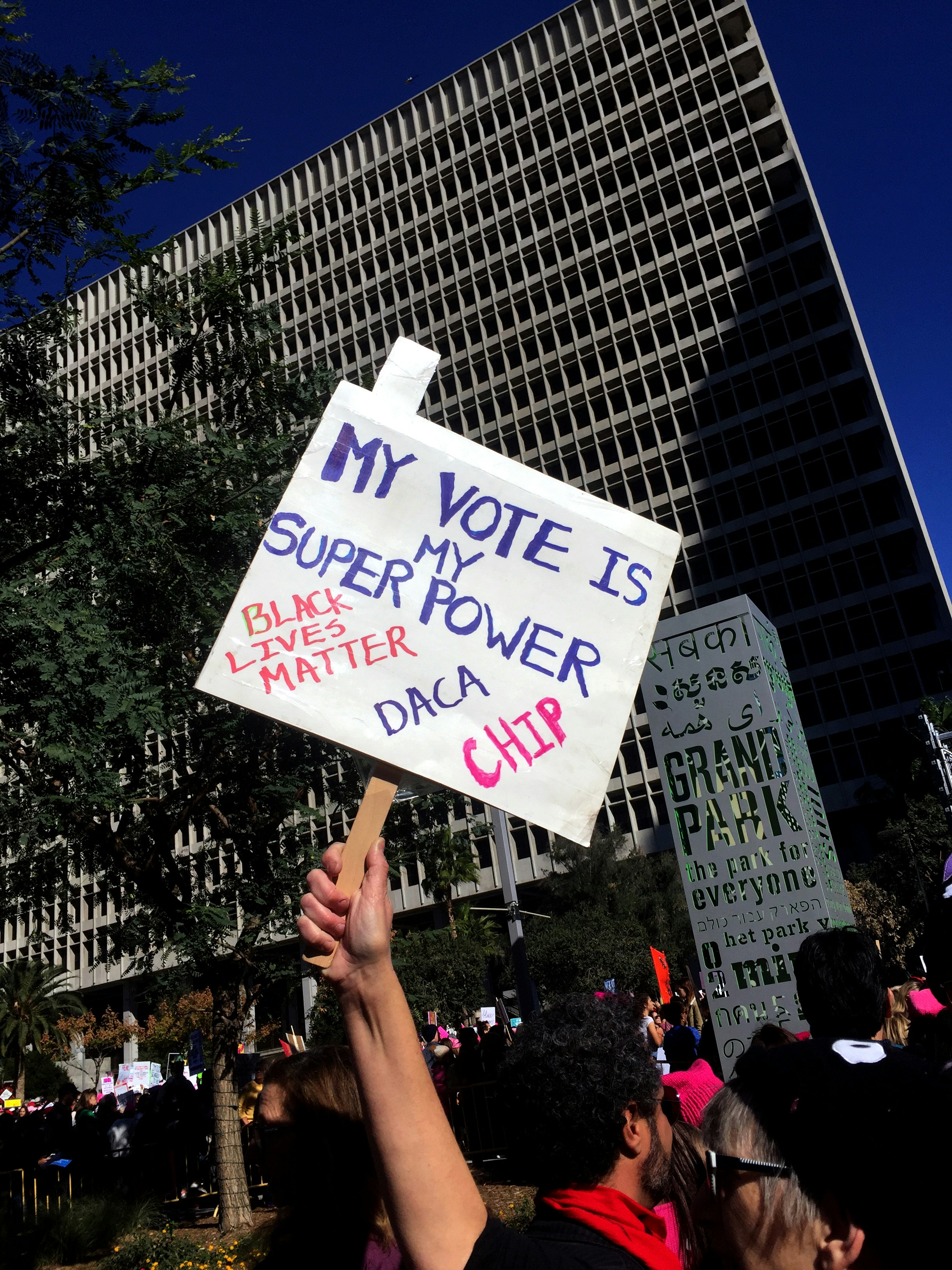A person holding a sign that says my vote is super power photo – Free ...