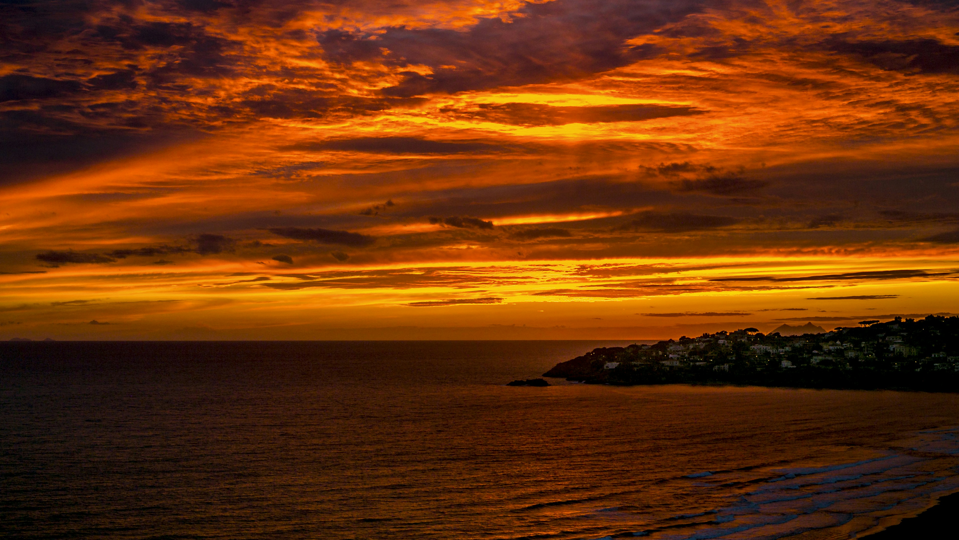 Crimson Horizon: Sunset Glow Over a Quiet Coastal Ridge