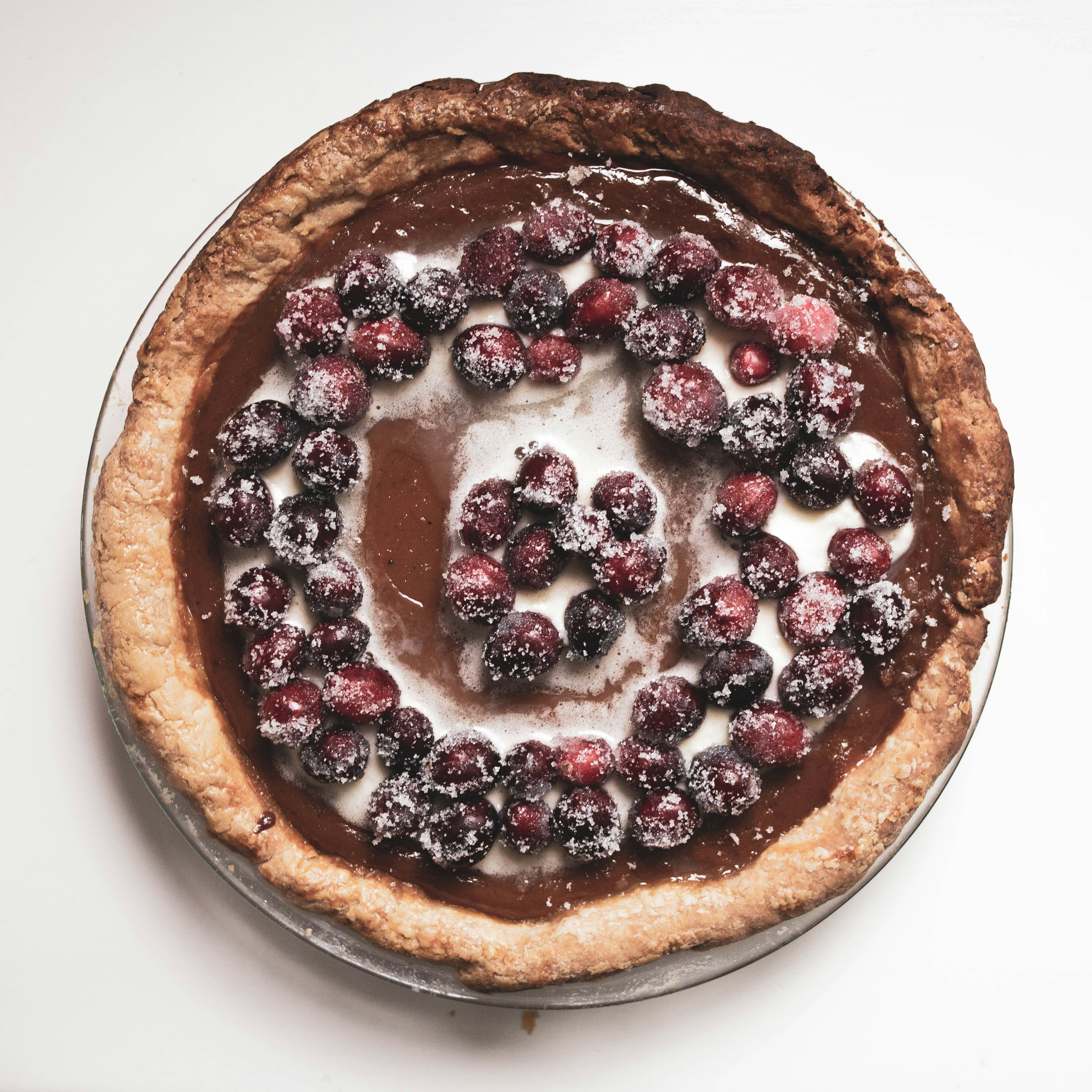 Brown and black pie with red and black berries on top photo – Free Food ...