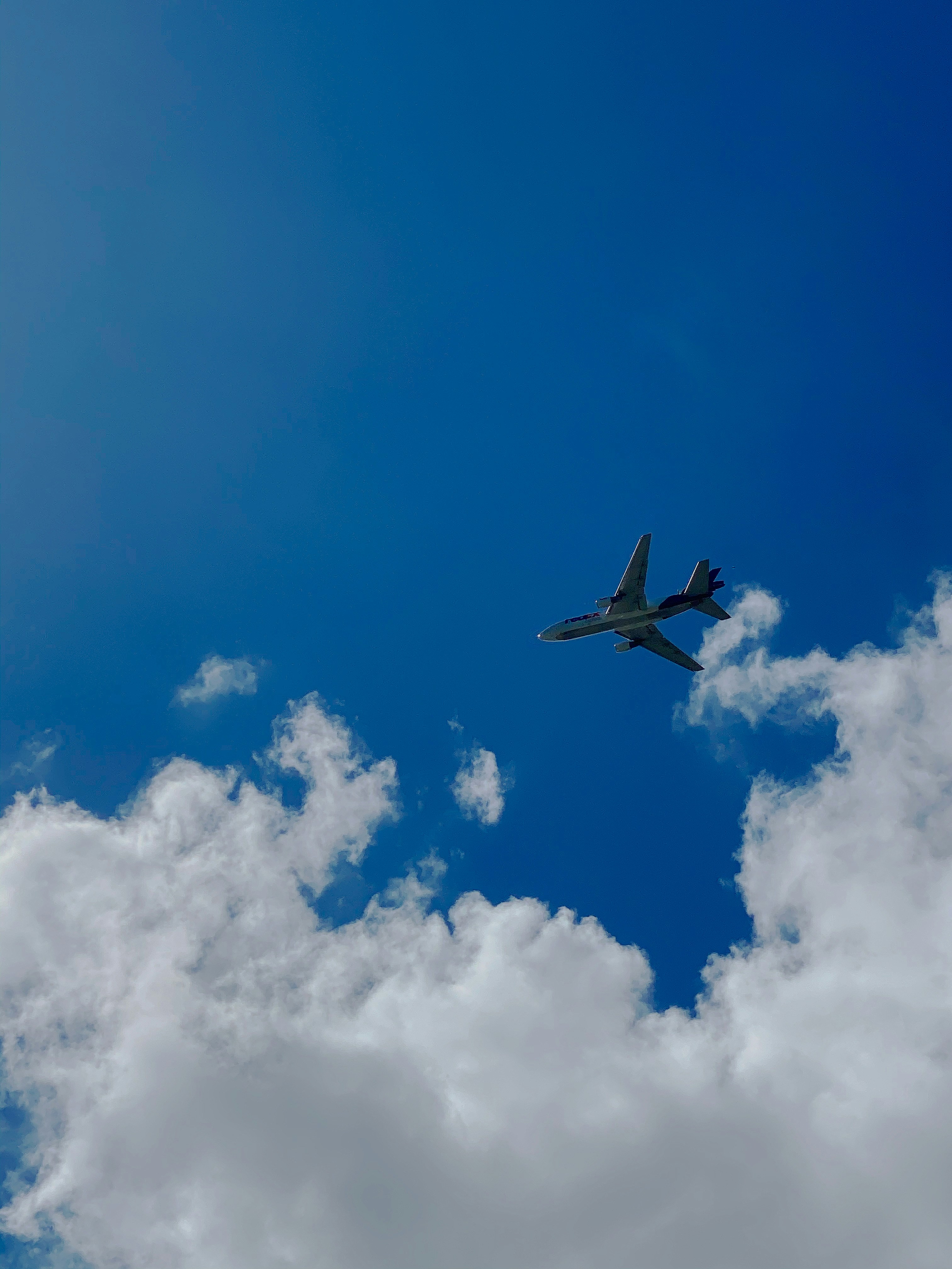 Black and white airplane in mid air under blue sky during daytime photo ...