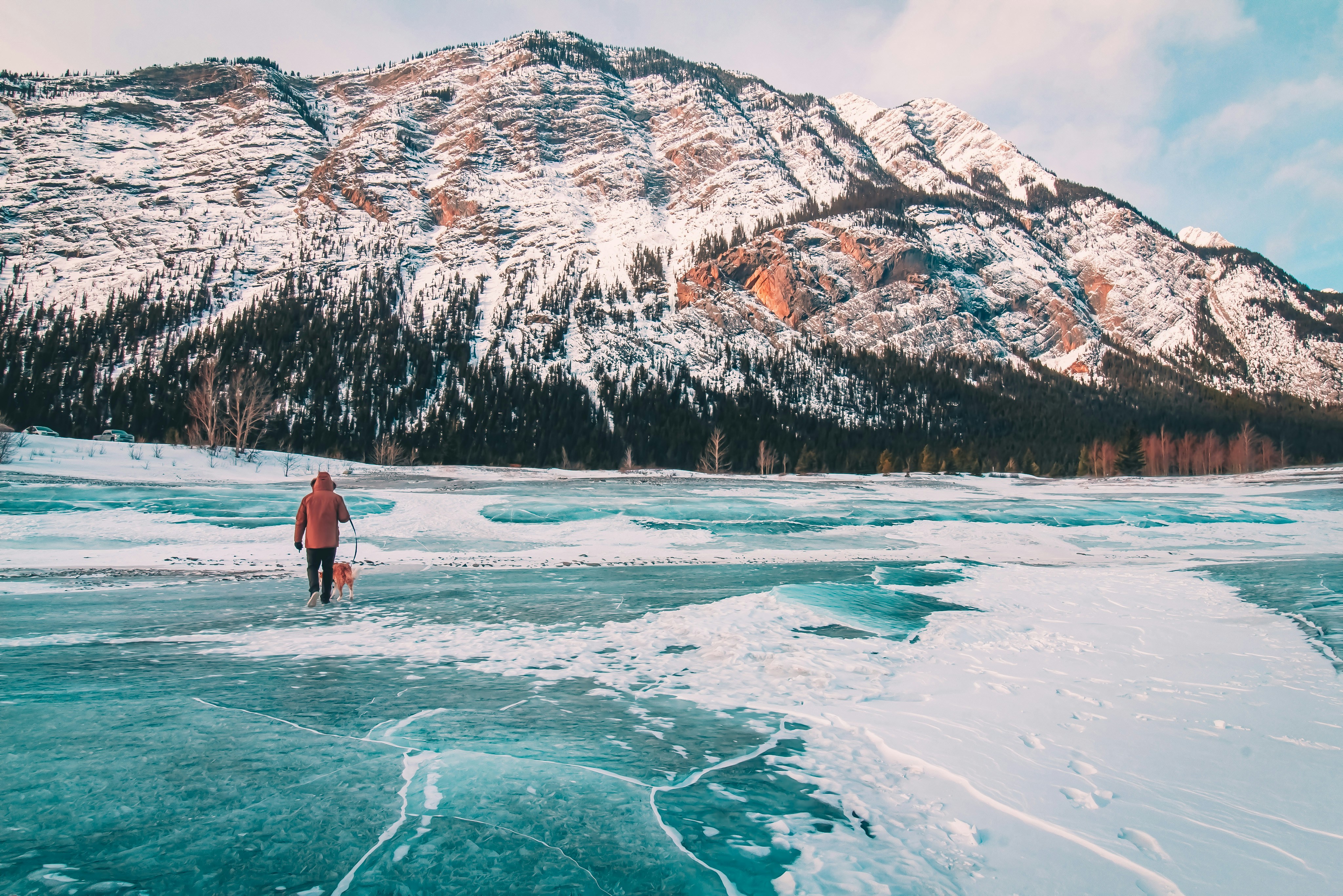 Cracked Ice Horizon: A Solitary Hiker Traverses a Glacier-Blue Lake