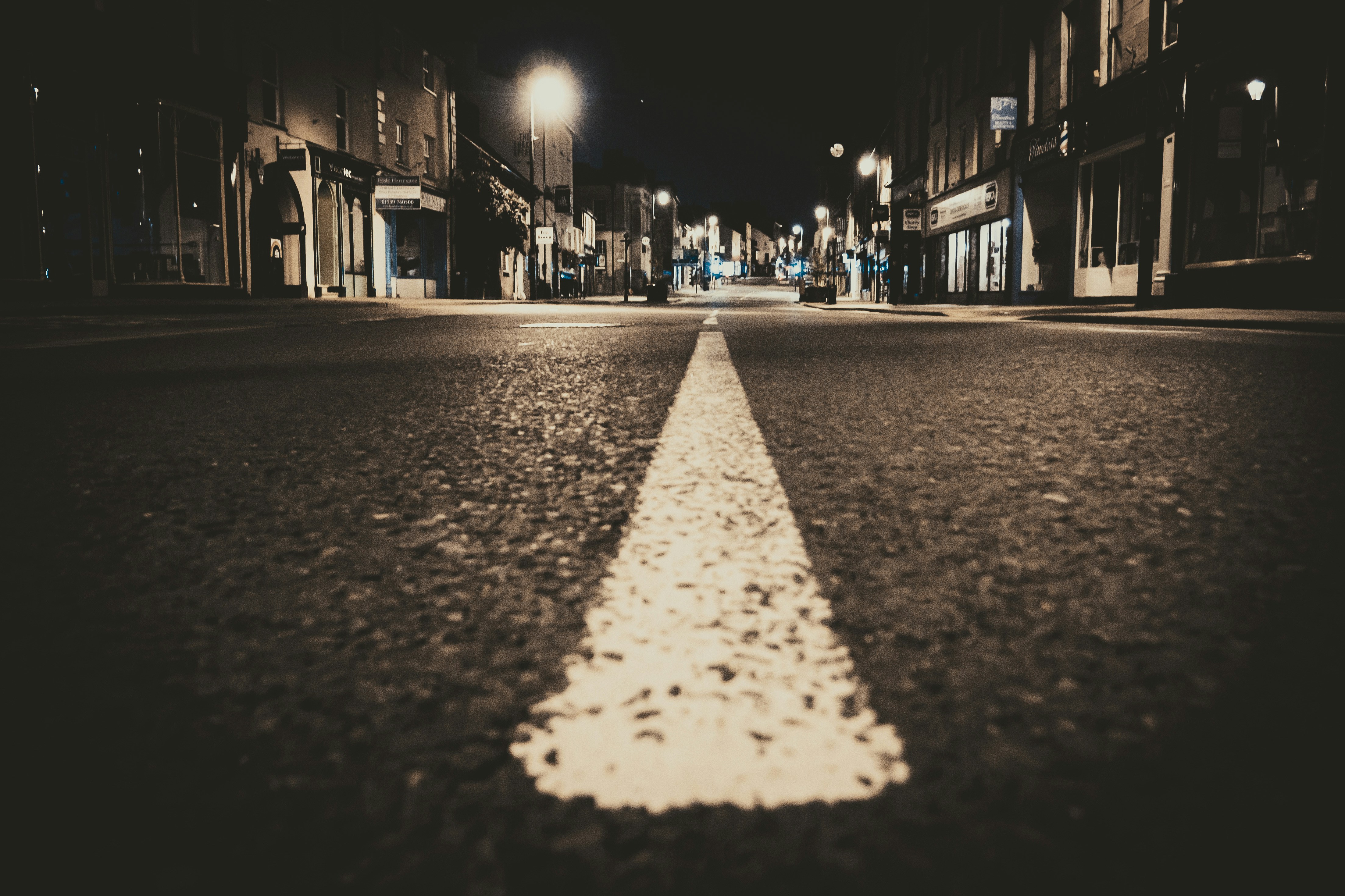 Grayscale photo of road between buildings photo – Free Kendal Image on ...
