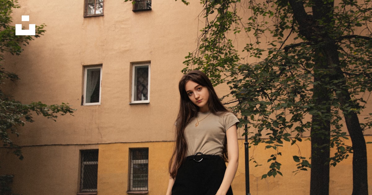 Foto Mujer Vestida De Negro Parada Cerca De Un Edificio De Hormigón