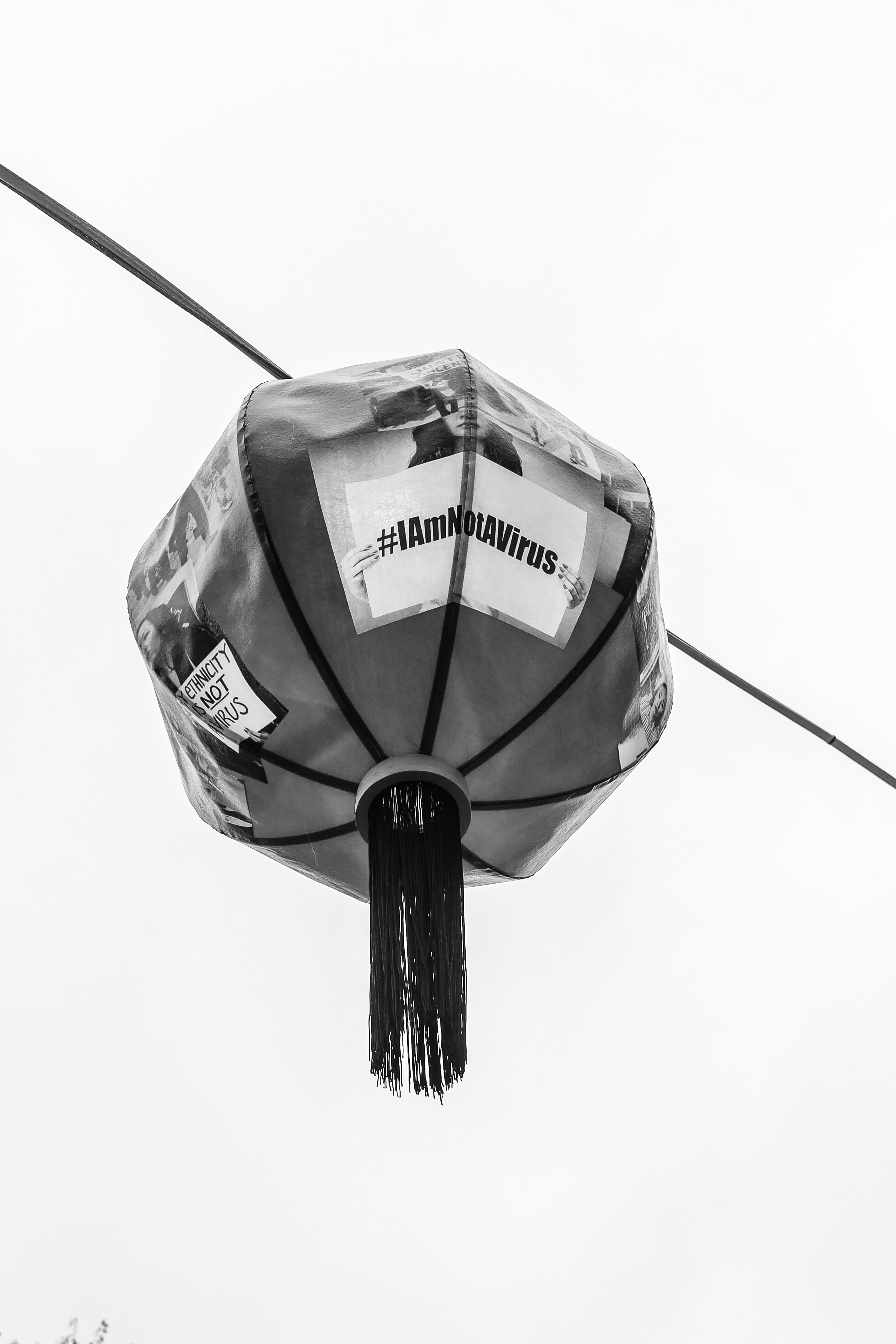 Floating lantern with protest stickers in grayscale