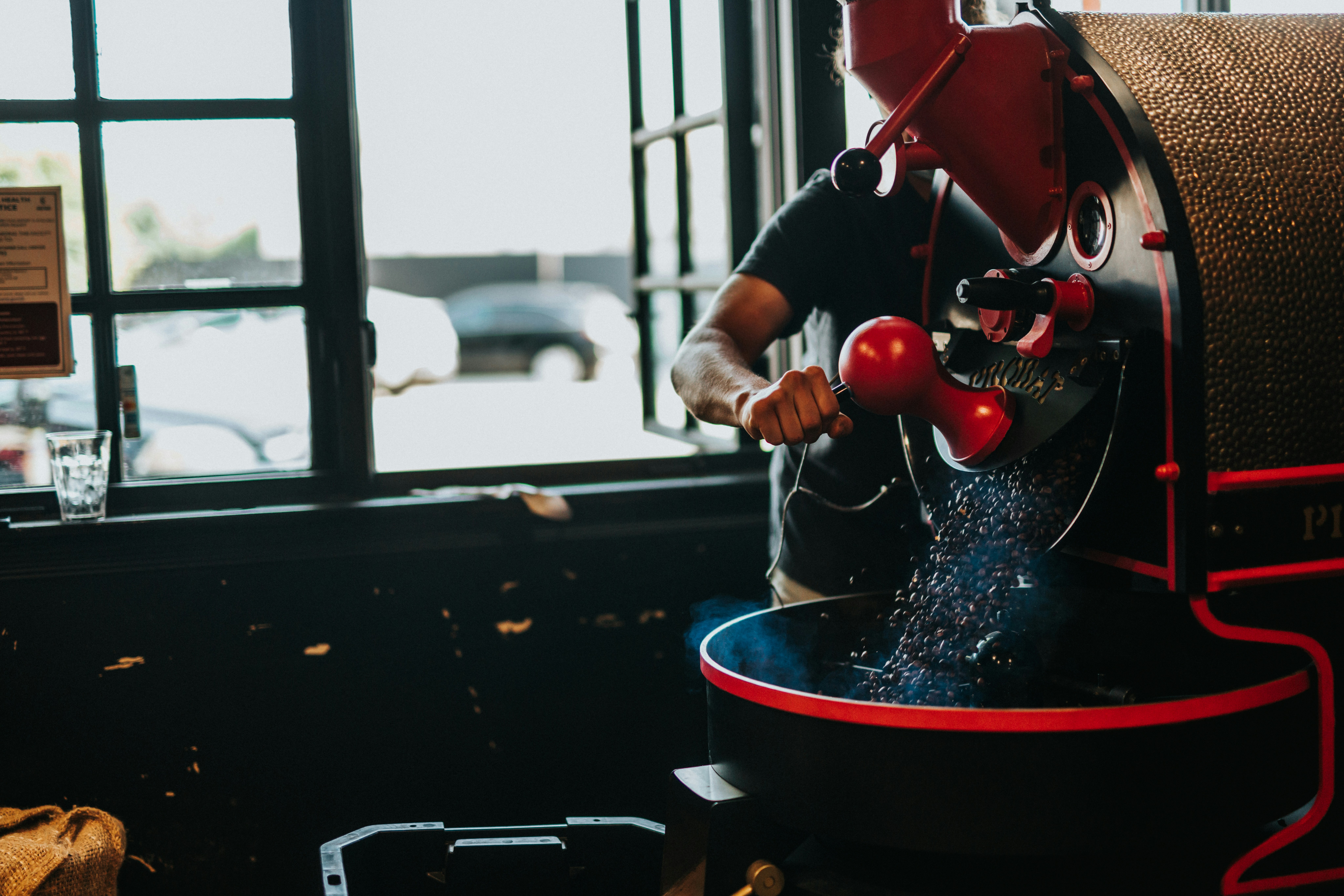 Crimson Drum Roaster in a Quiet Café: Hands Craft the Roast