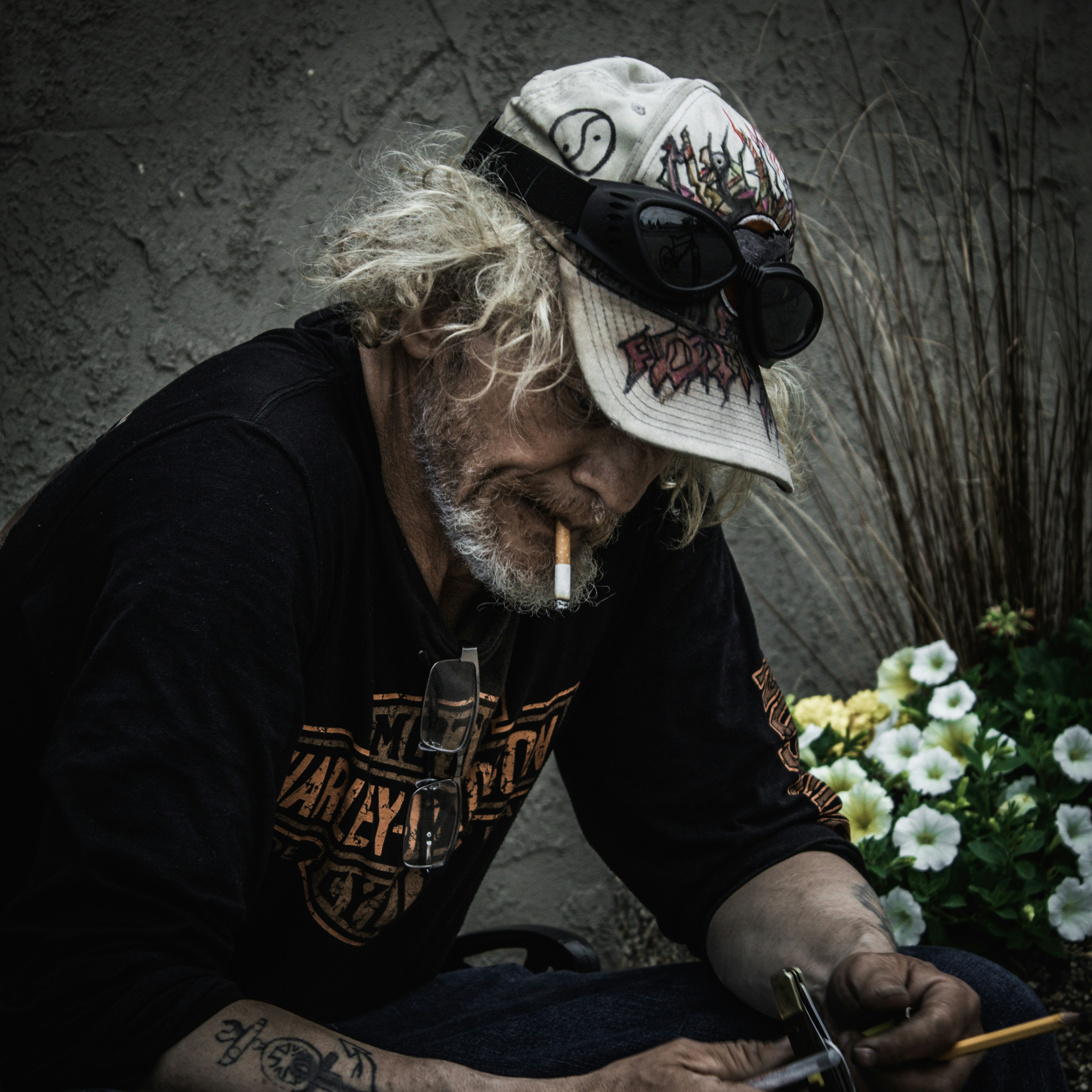  Cigarette and cap: a weathered guitarist at dusk