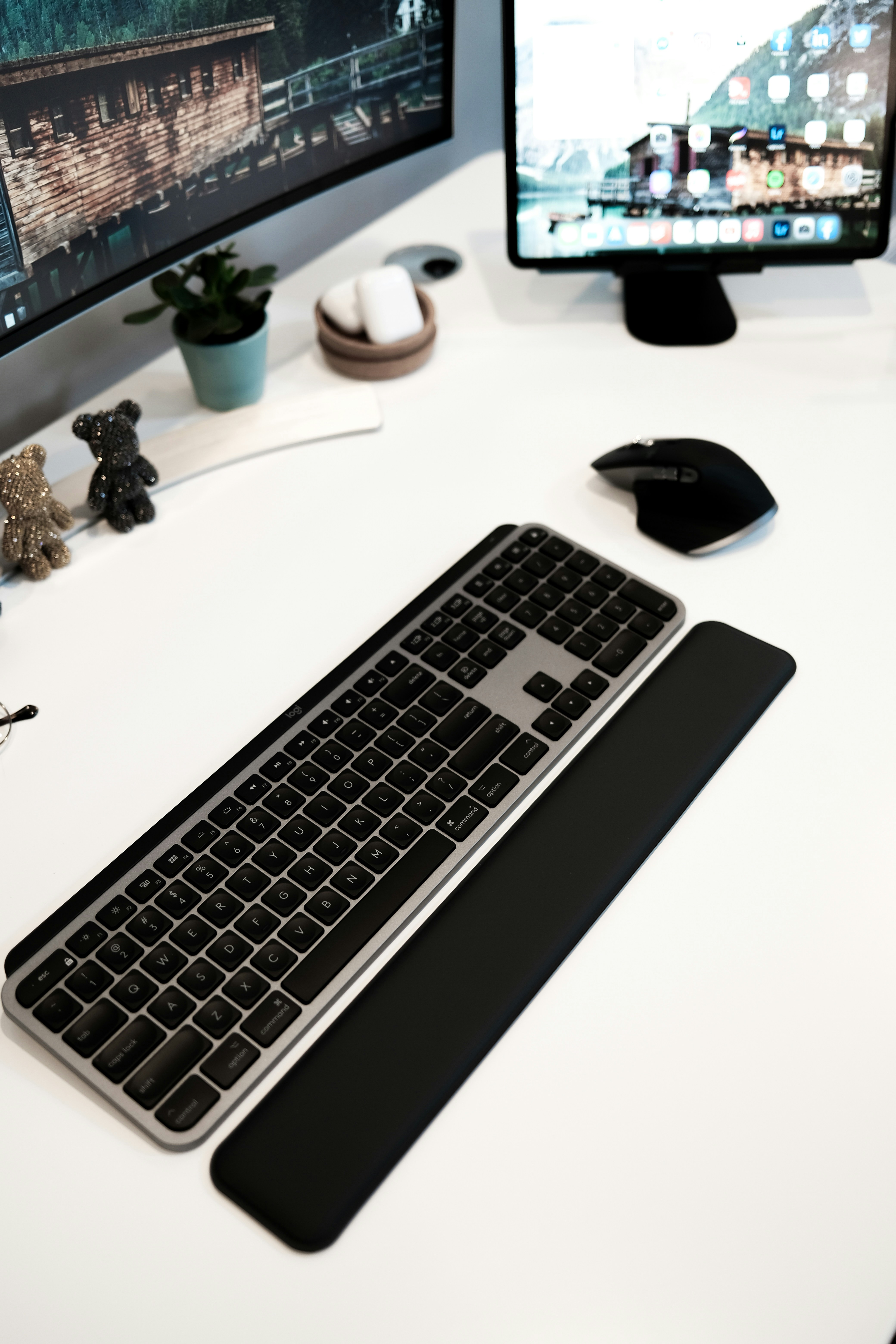 Black and silver computer keyboard beside black flat screen computer ...