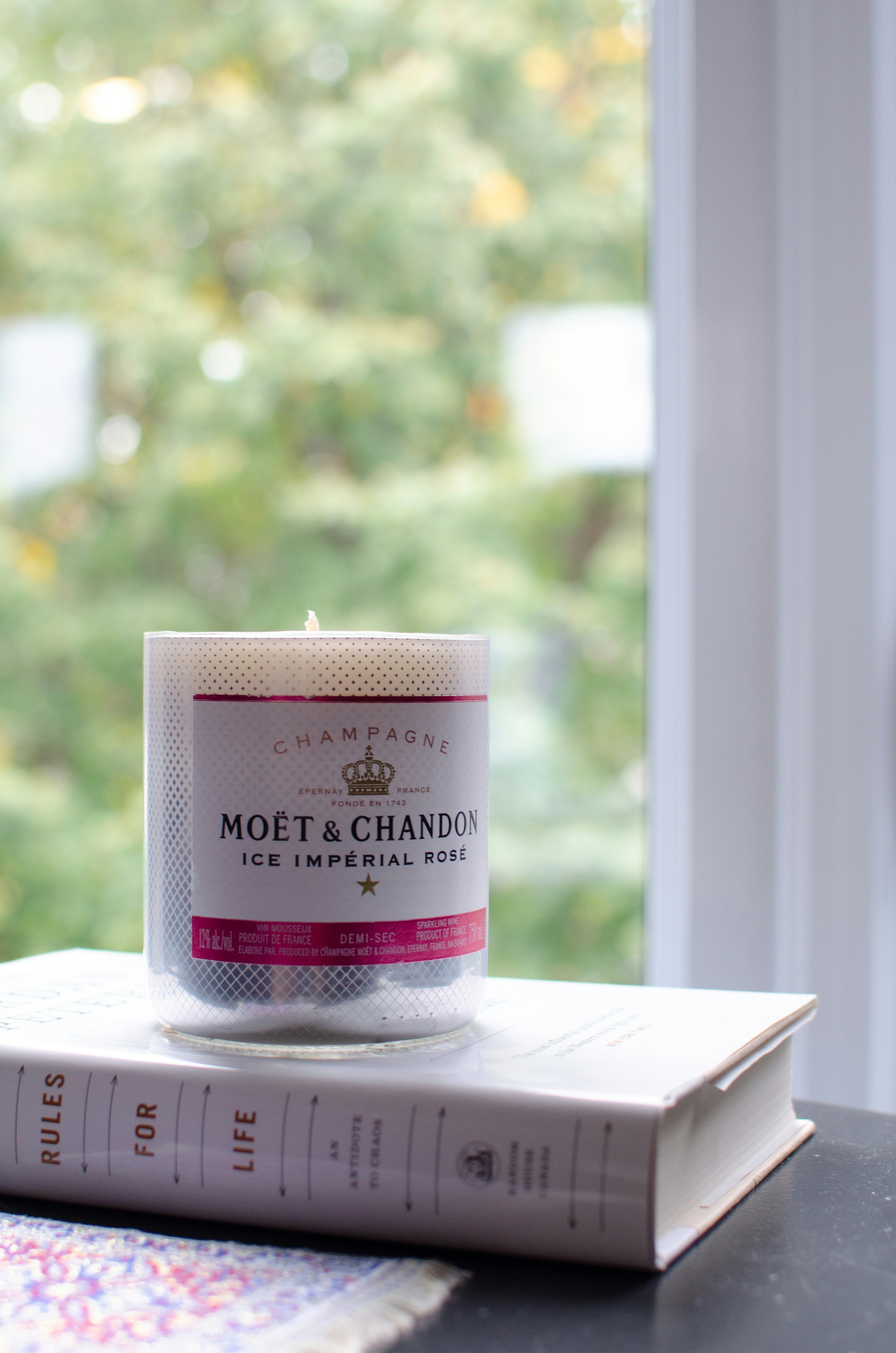 Moët Candlelight on a Quiet Desk: Champagne, Light, and a Book