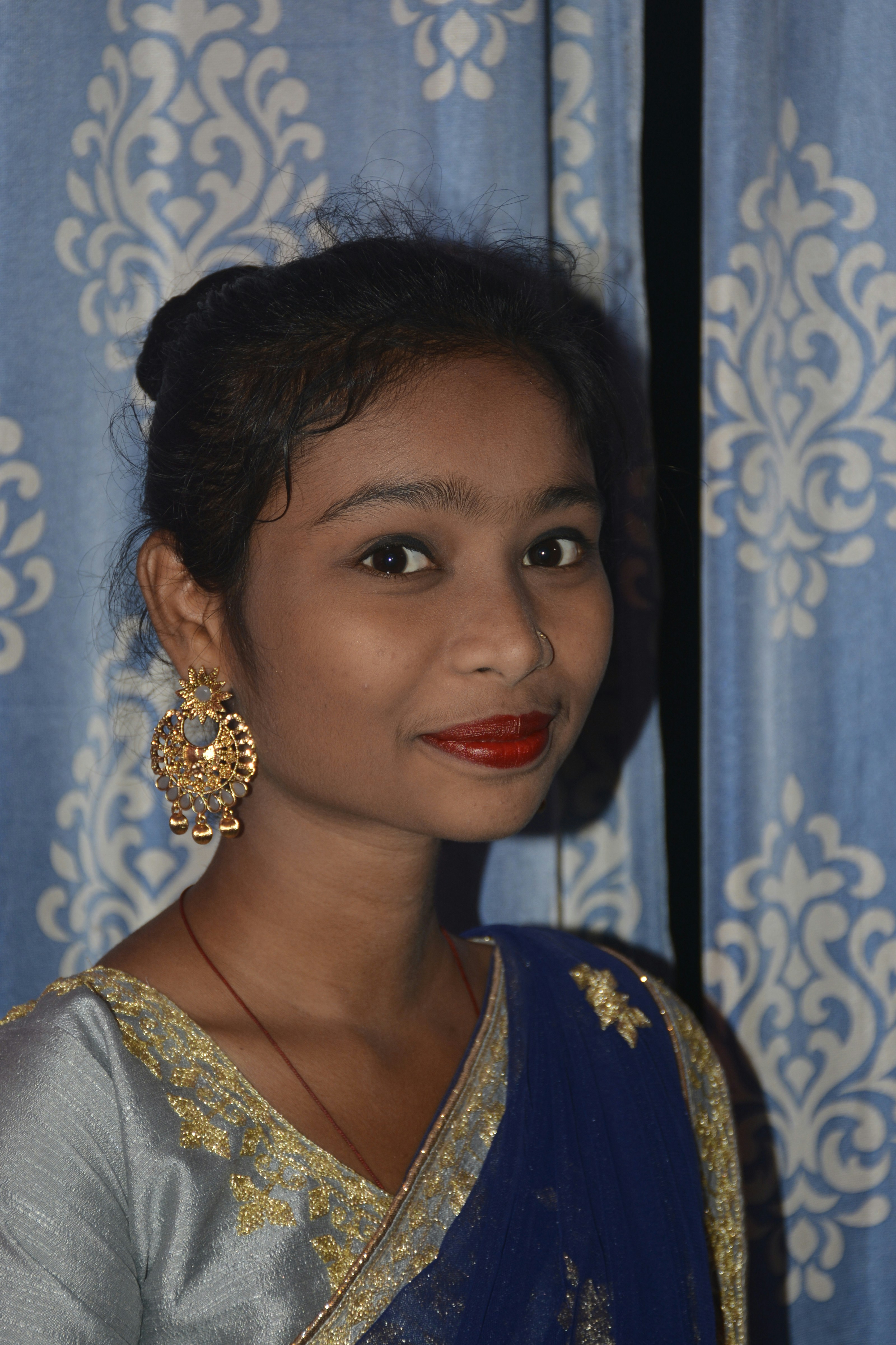 Blue Silk Portrait: Graceful Glow with Gold Earring