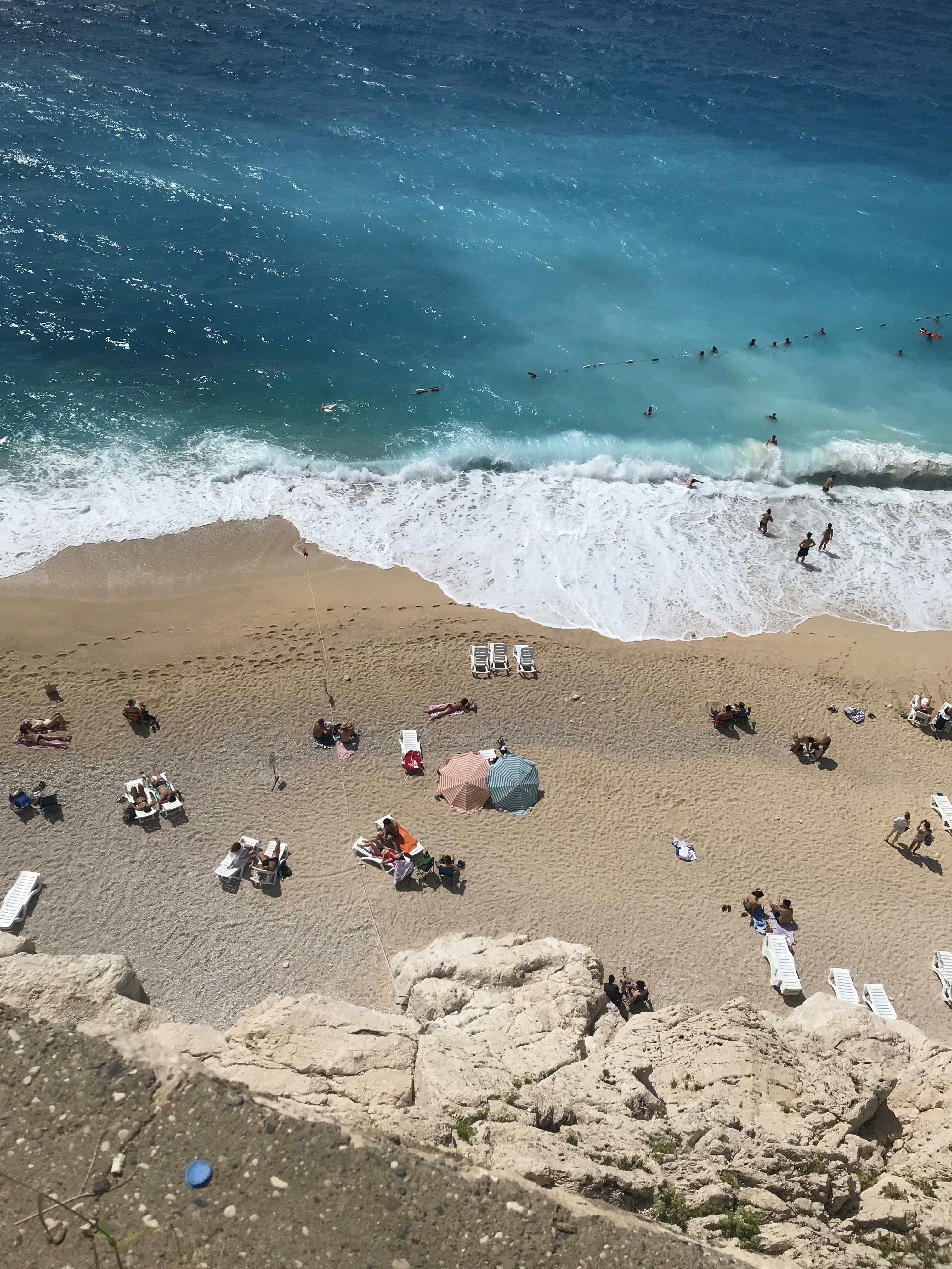 Teal Tide and Umbrella Cluster: A Quiet Beachtop Scene