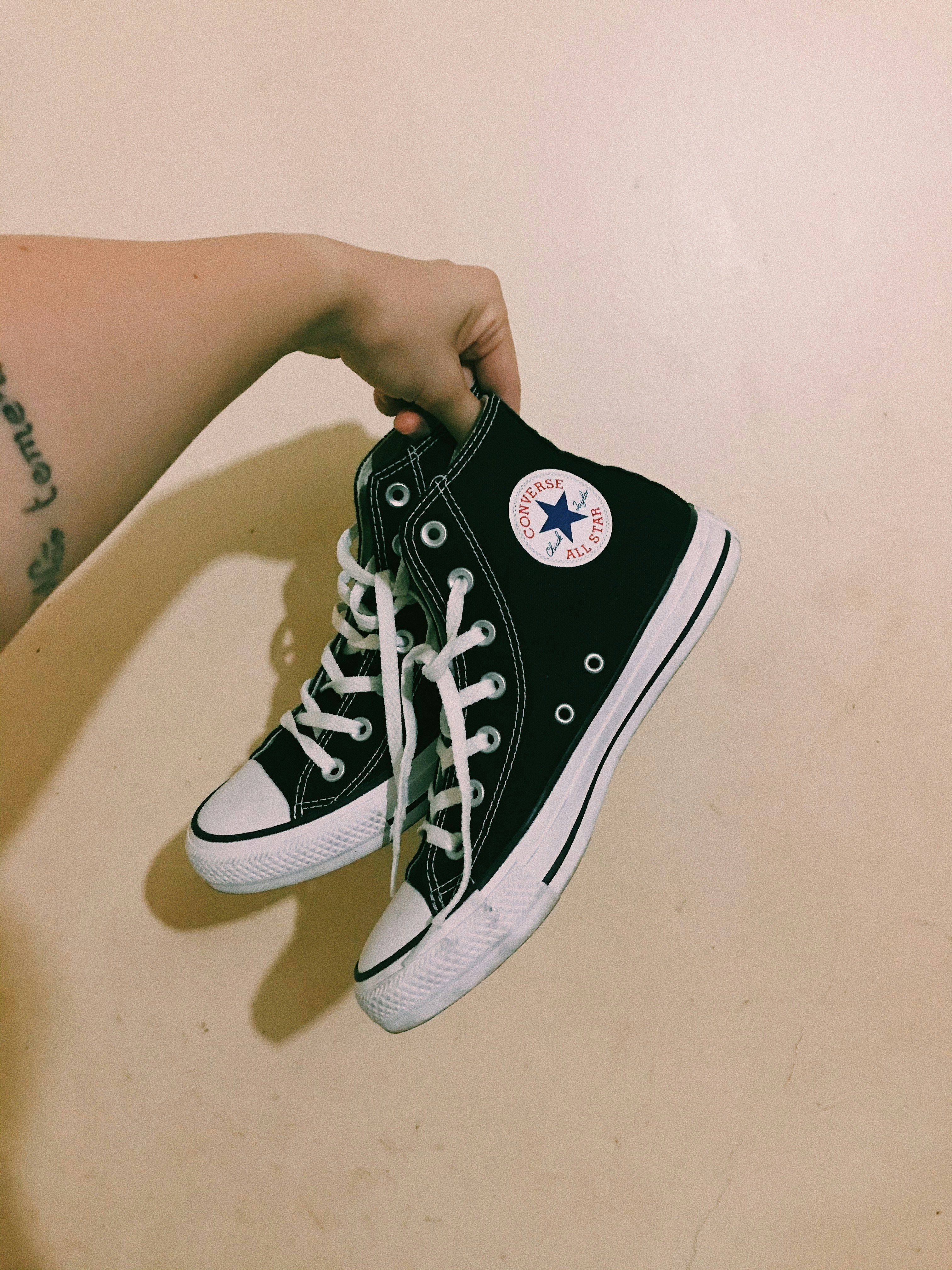 Person wearing black converse all star high top sneakers photo – Free ...