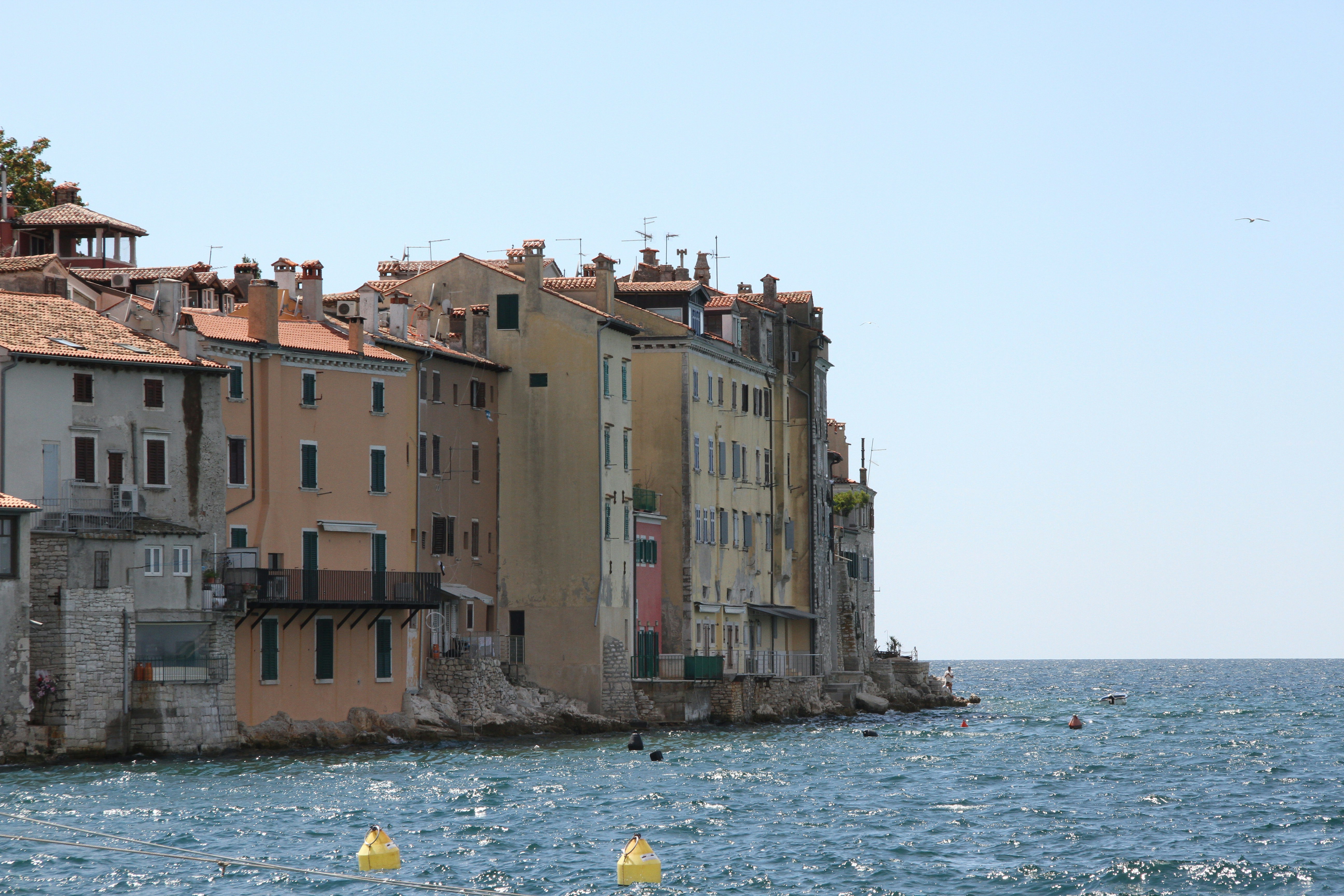 Colorful buildings lining the shoreline, reflecting the charm of coastal life against a serene sea backdrop.