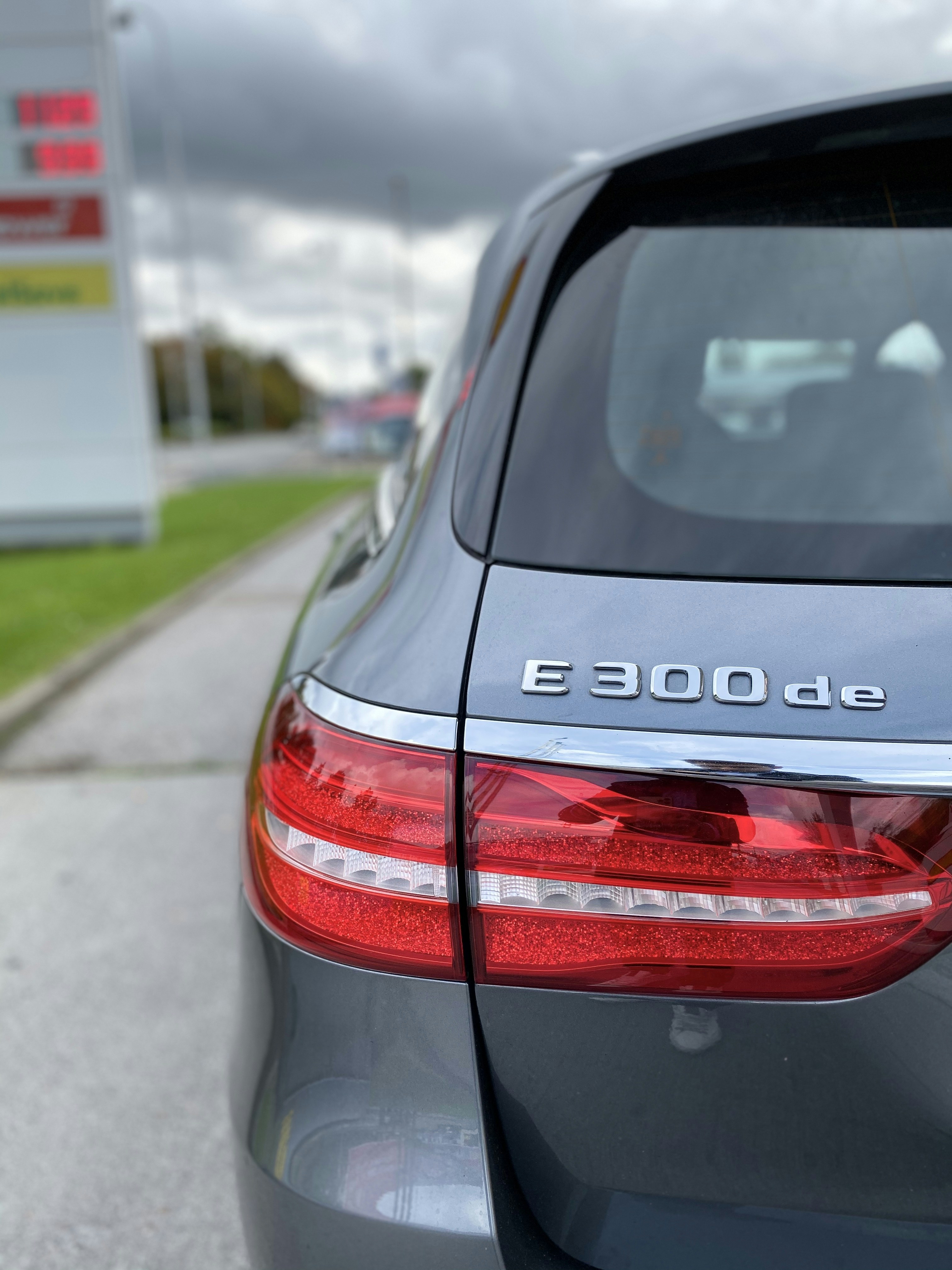 Rear view of a Mercedes E300 de with glossy grey finish and distinctive taillights.
