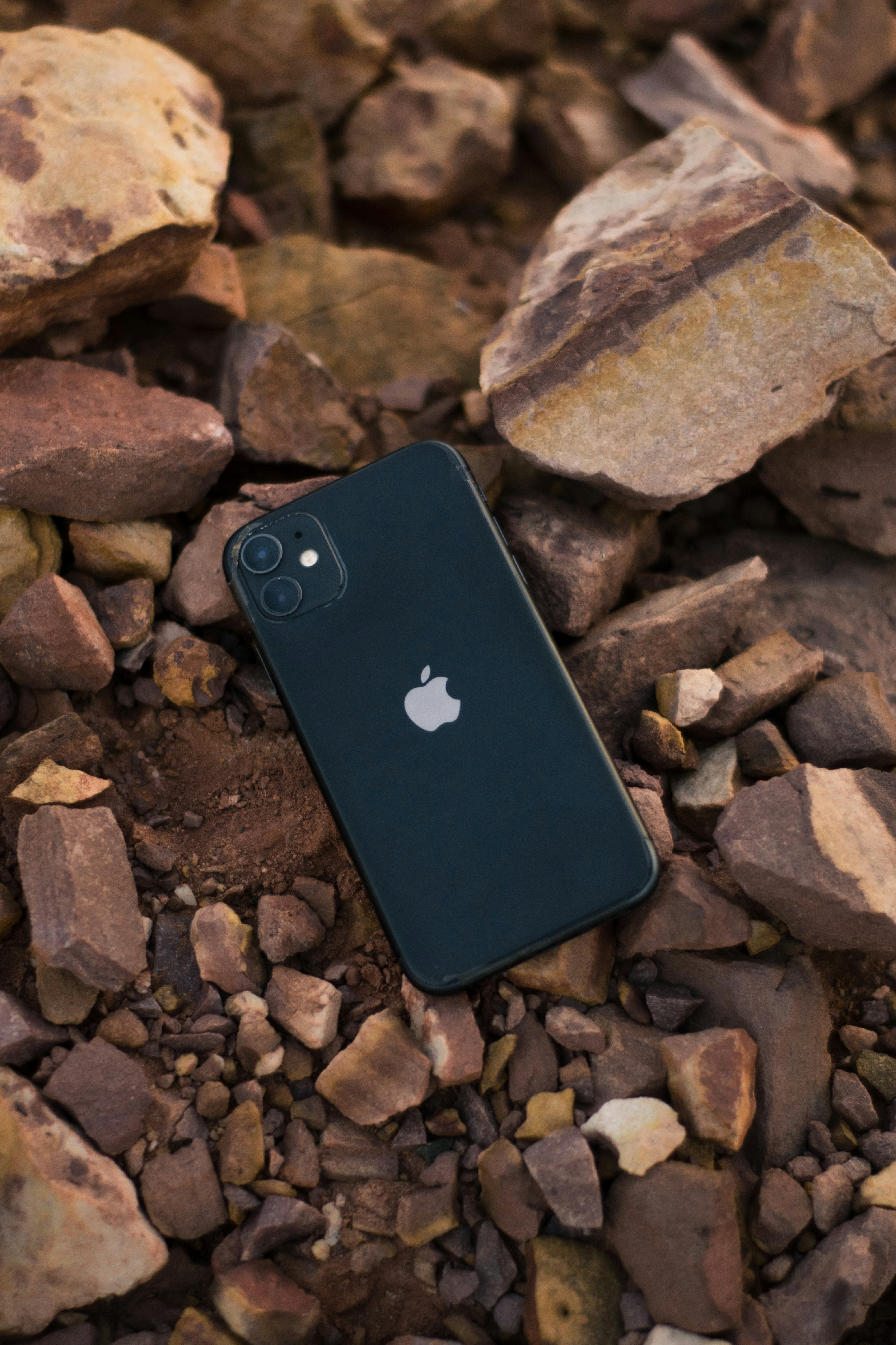Obsidian iPhone Nestled in a Gravel Bed