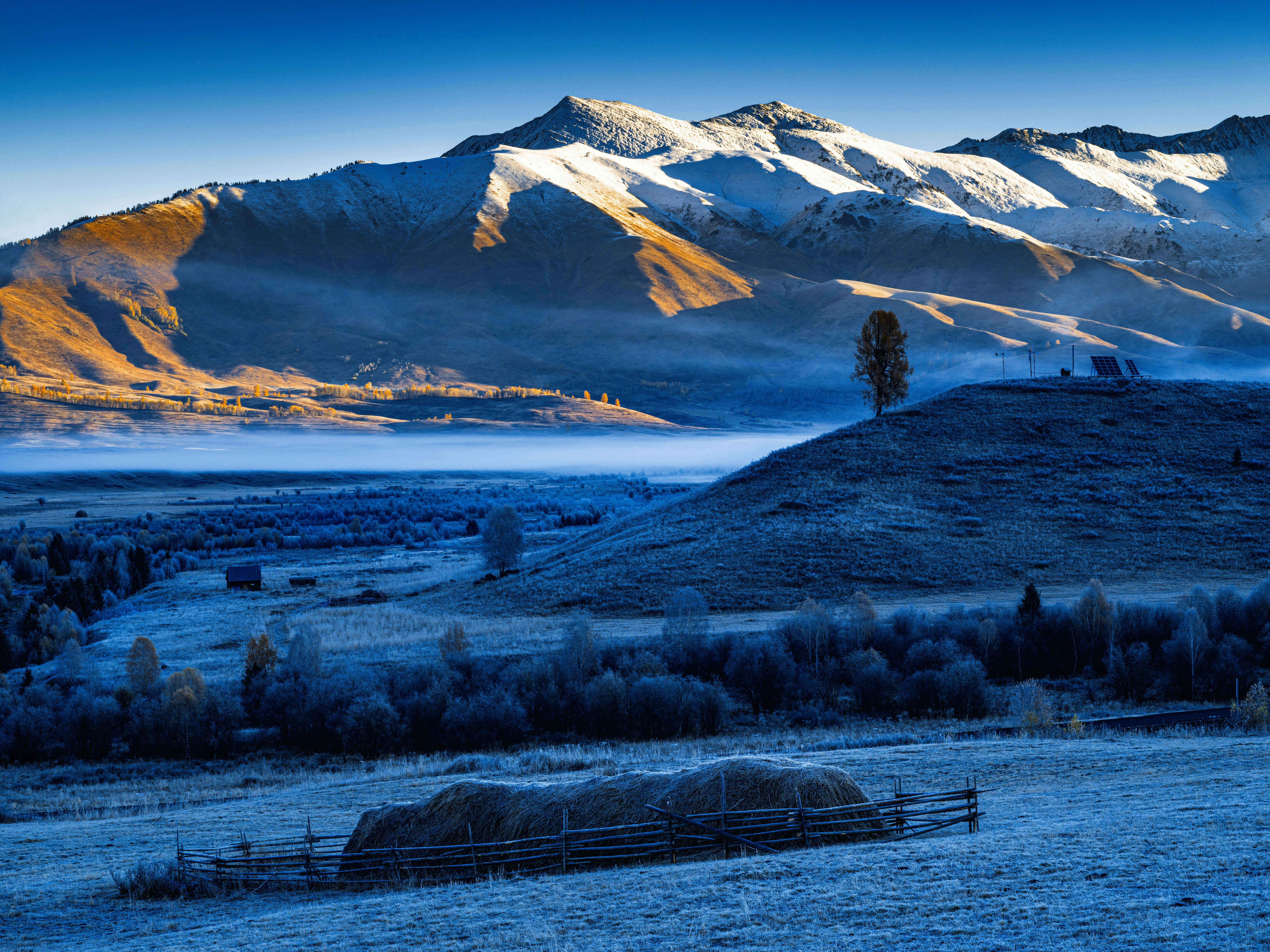 Sunlit Peaks Over Cold Valleys