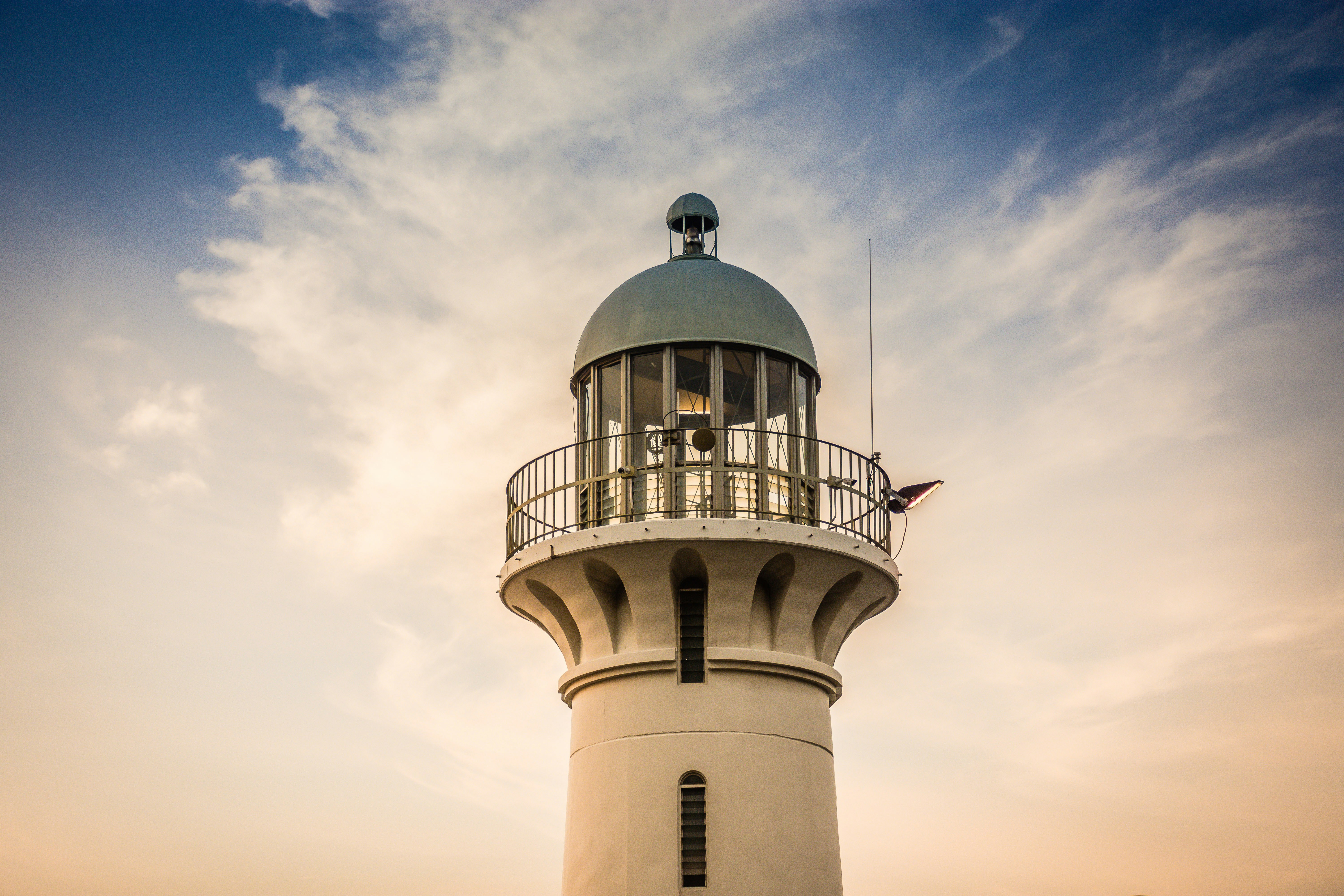A white lighthouse with a blue sky in the background photo – Free Tuas ...