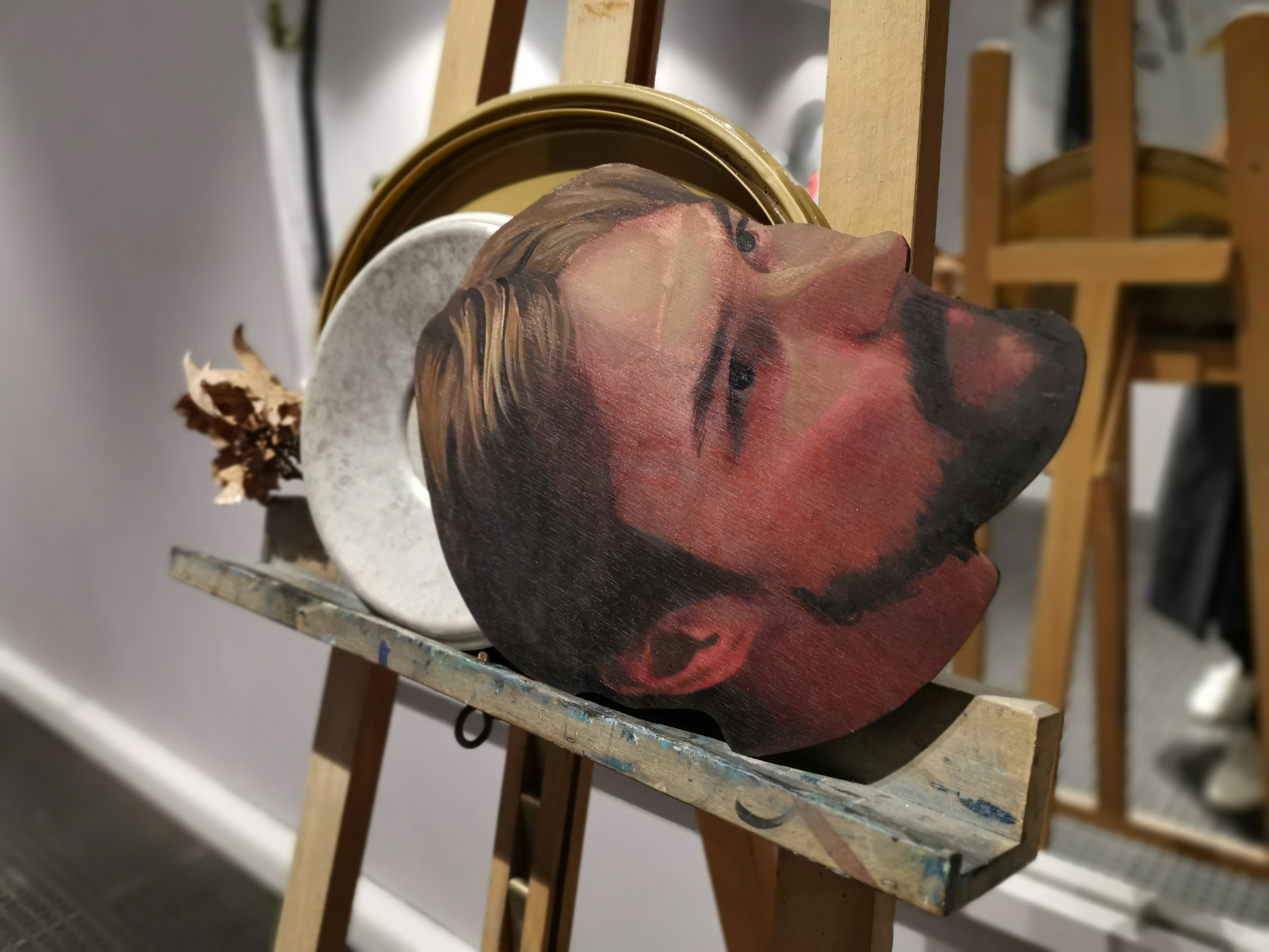 Portrait of a Cutout Face on a Painting Pallet Surrounded by Studio Props