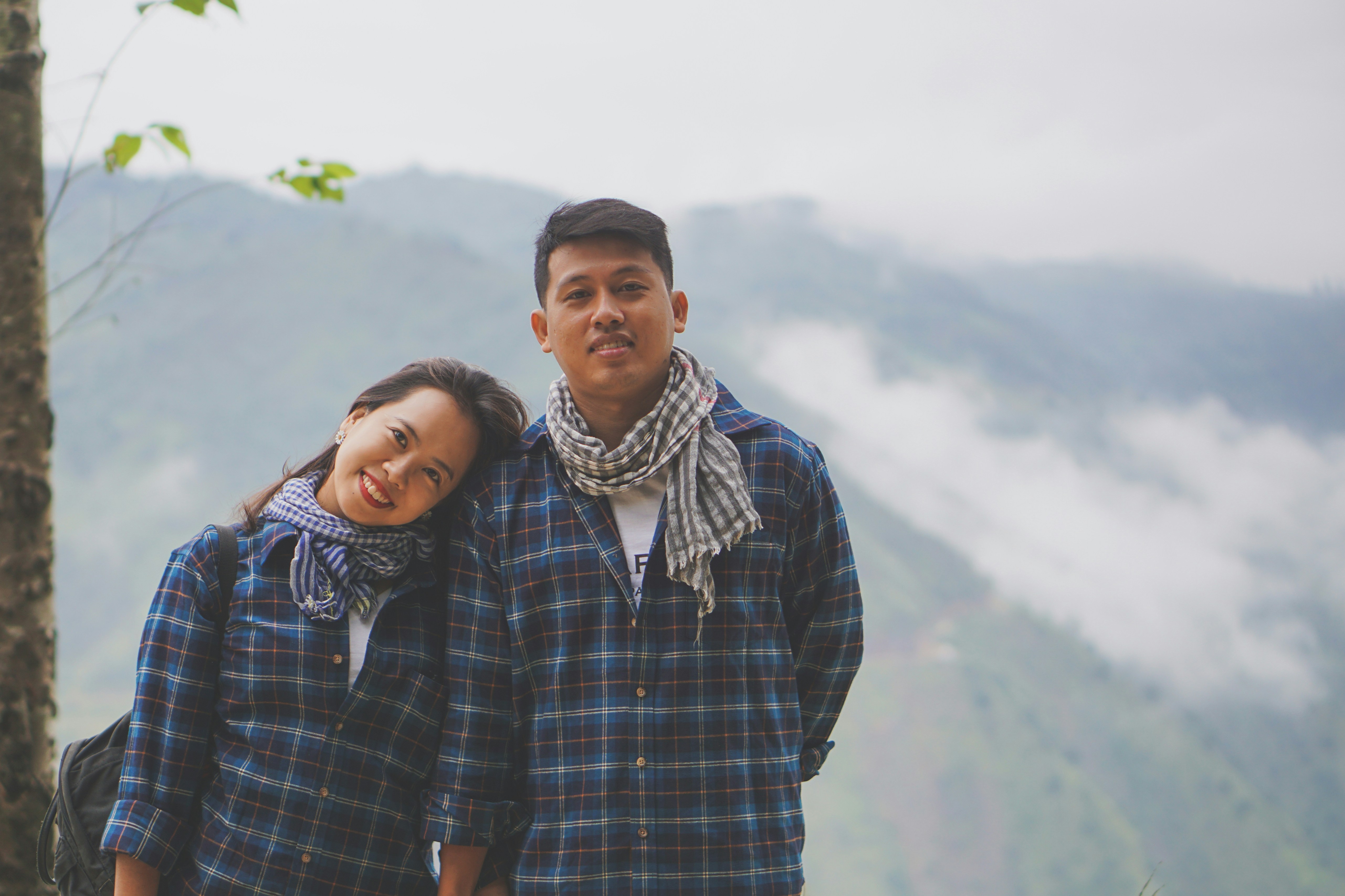 man in blue and white plaid dress shirt beside woman in black and white plaid dress