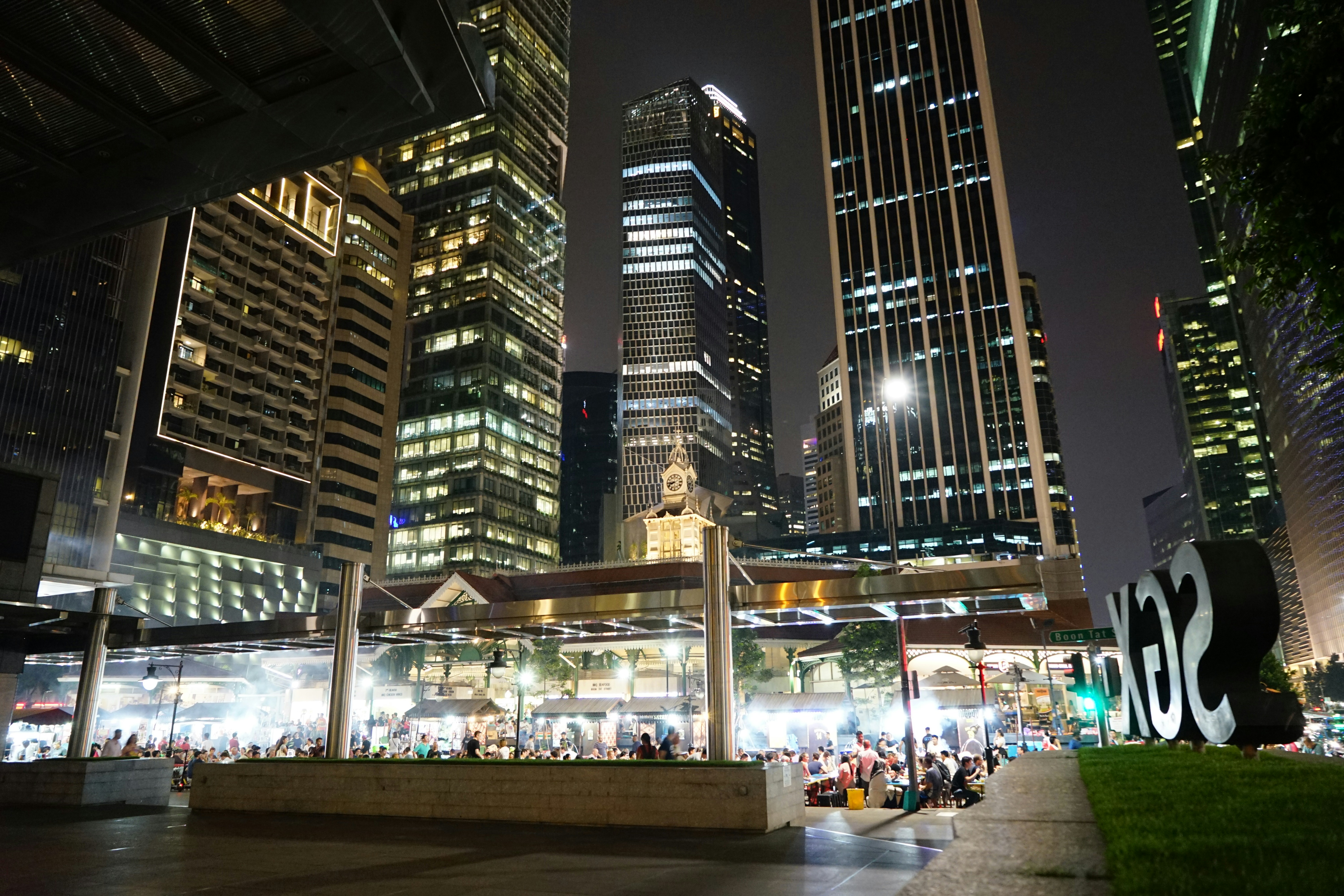 Cars parked on parking lot near high rise buildings during night time ...