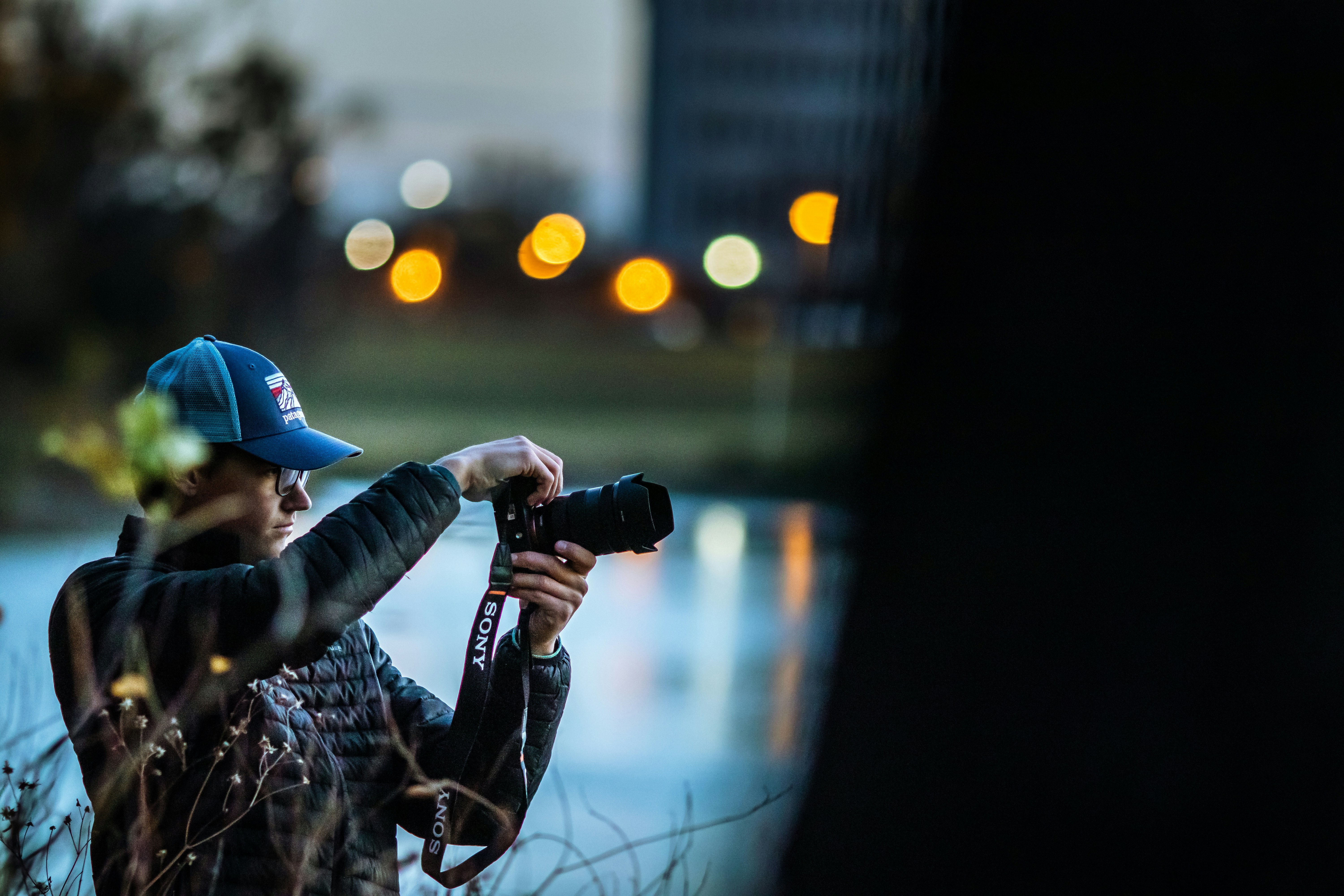 Man in blue cap holding black dslr camera photo – Free Portrait Image ...