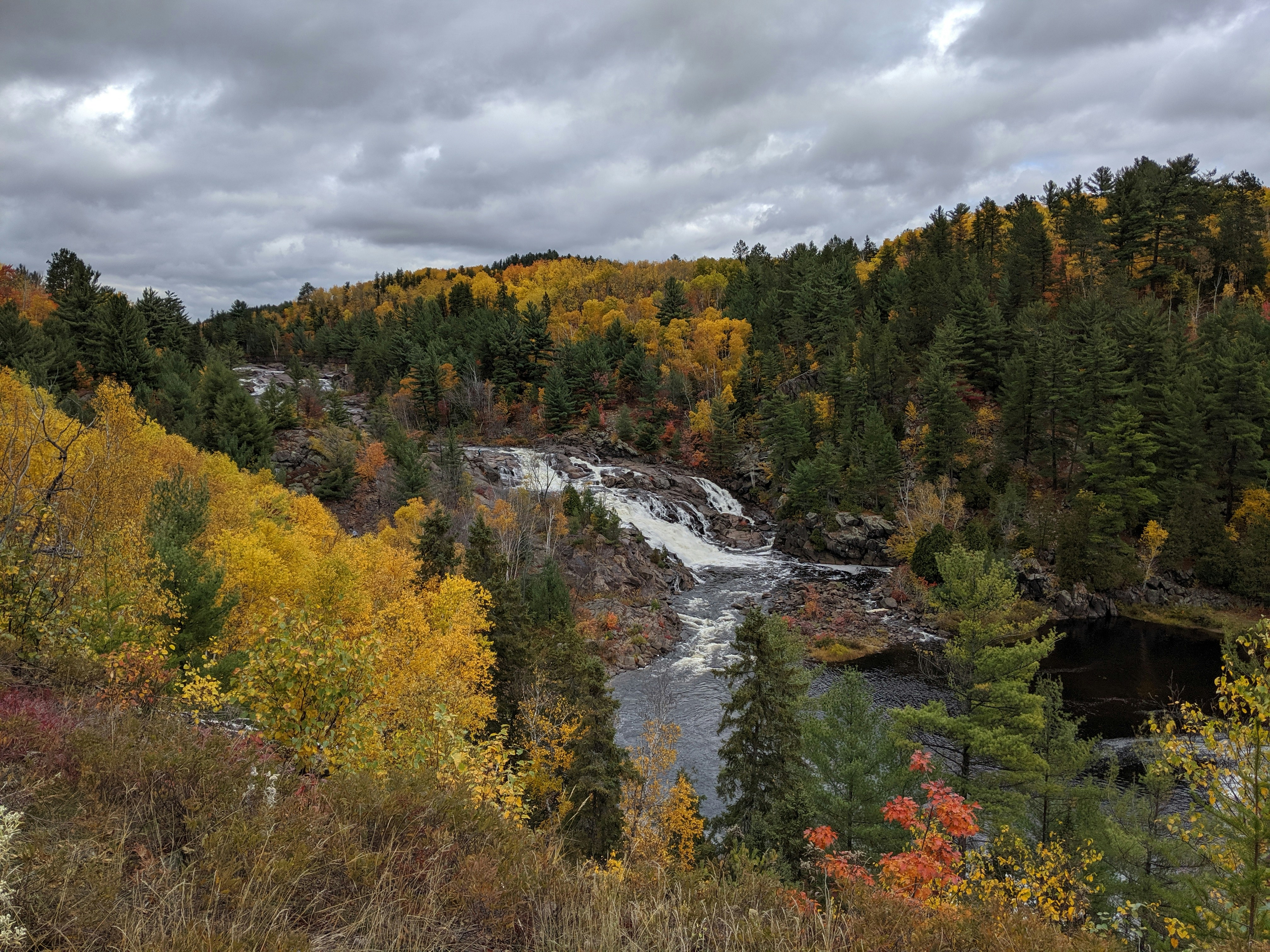 High Falls. Onaping, Ontario | green and yellow trees under white clouds during daytime