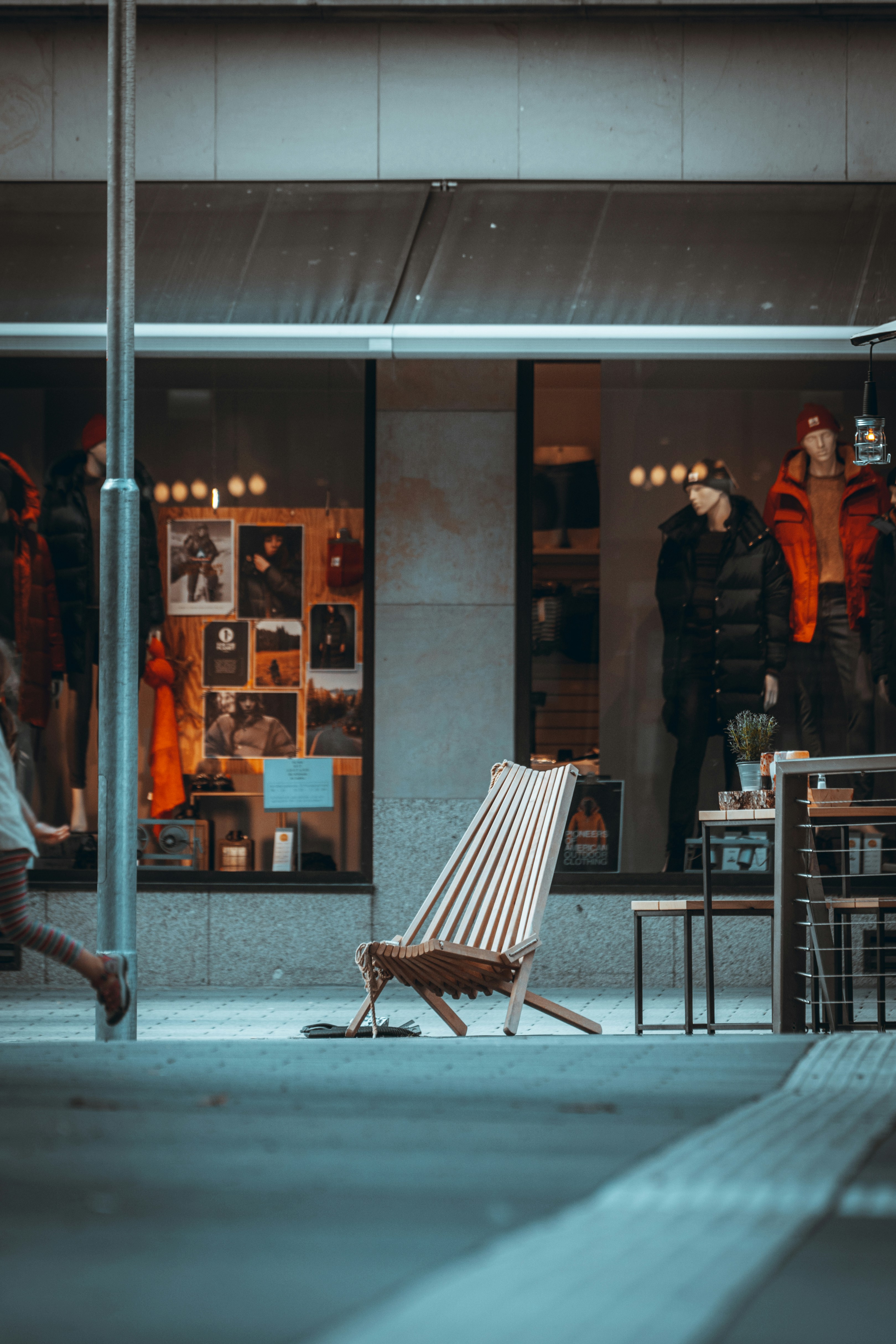 Urban Pause: The Empty Chair Framing a Warm Storefront