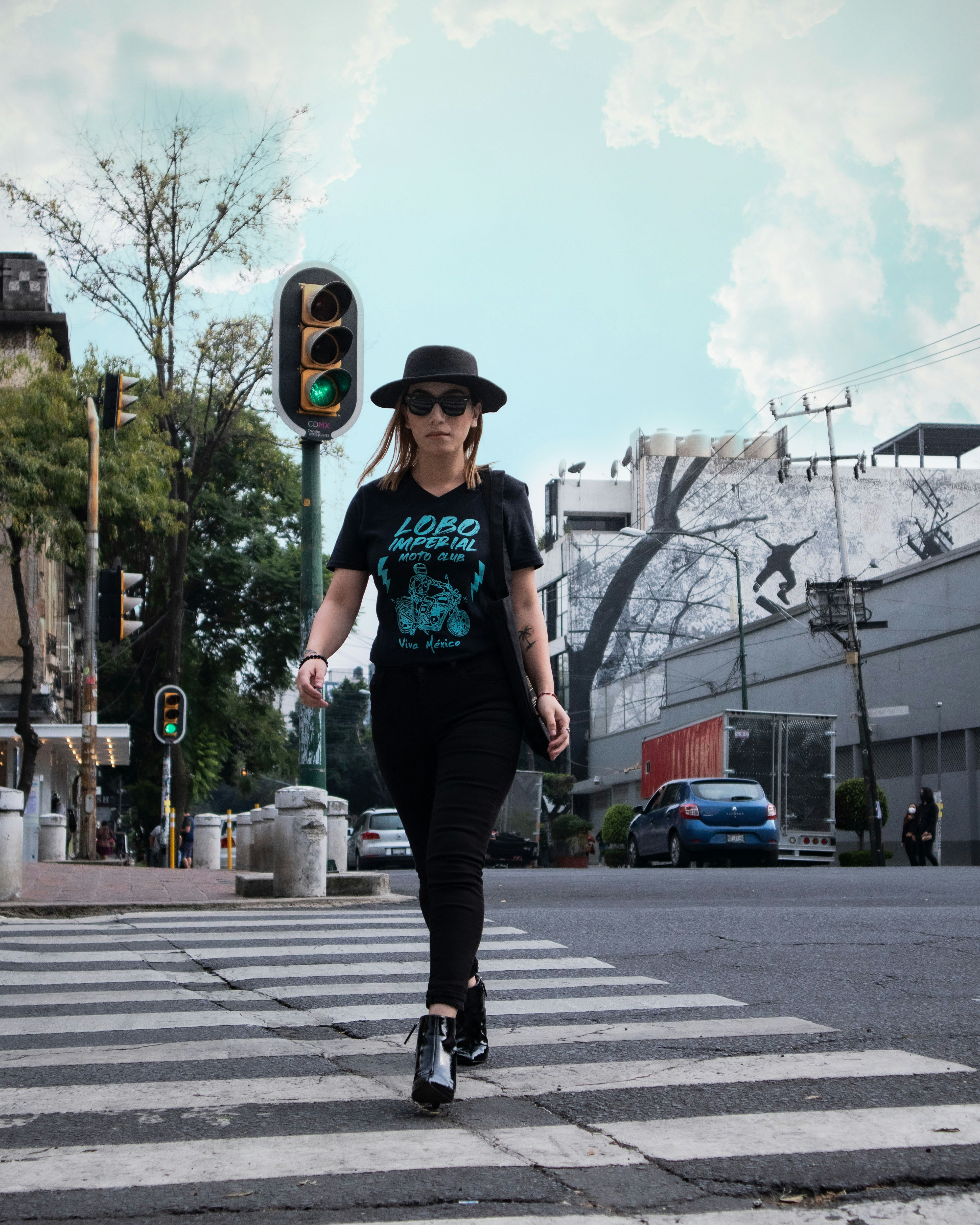 Crosswalk Cadence: A Bold Figure Stepping Through Urban Graffiti