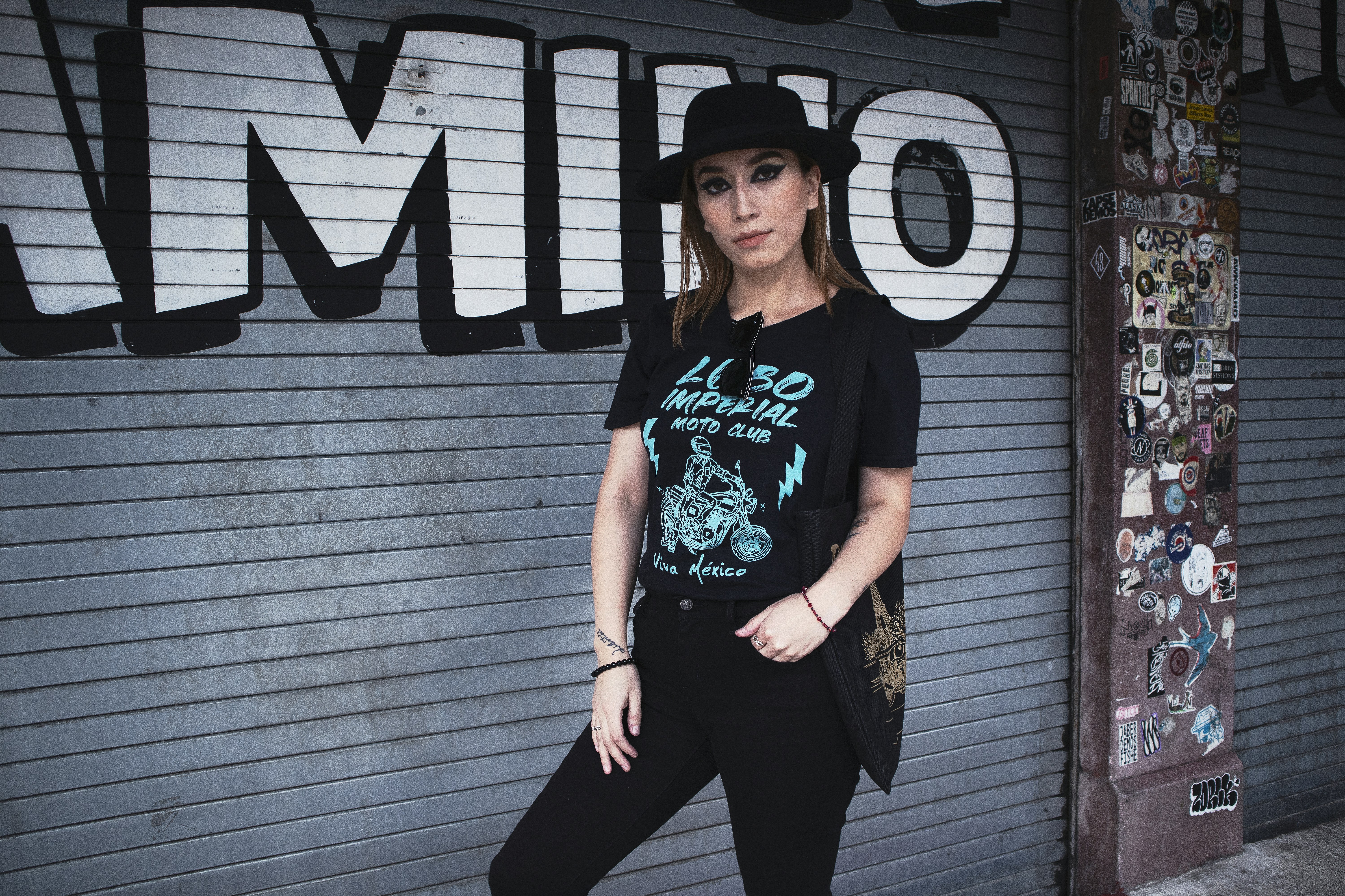 Street-side Portrait in Front of a Graffiti-Backed Roll-Up