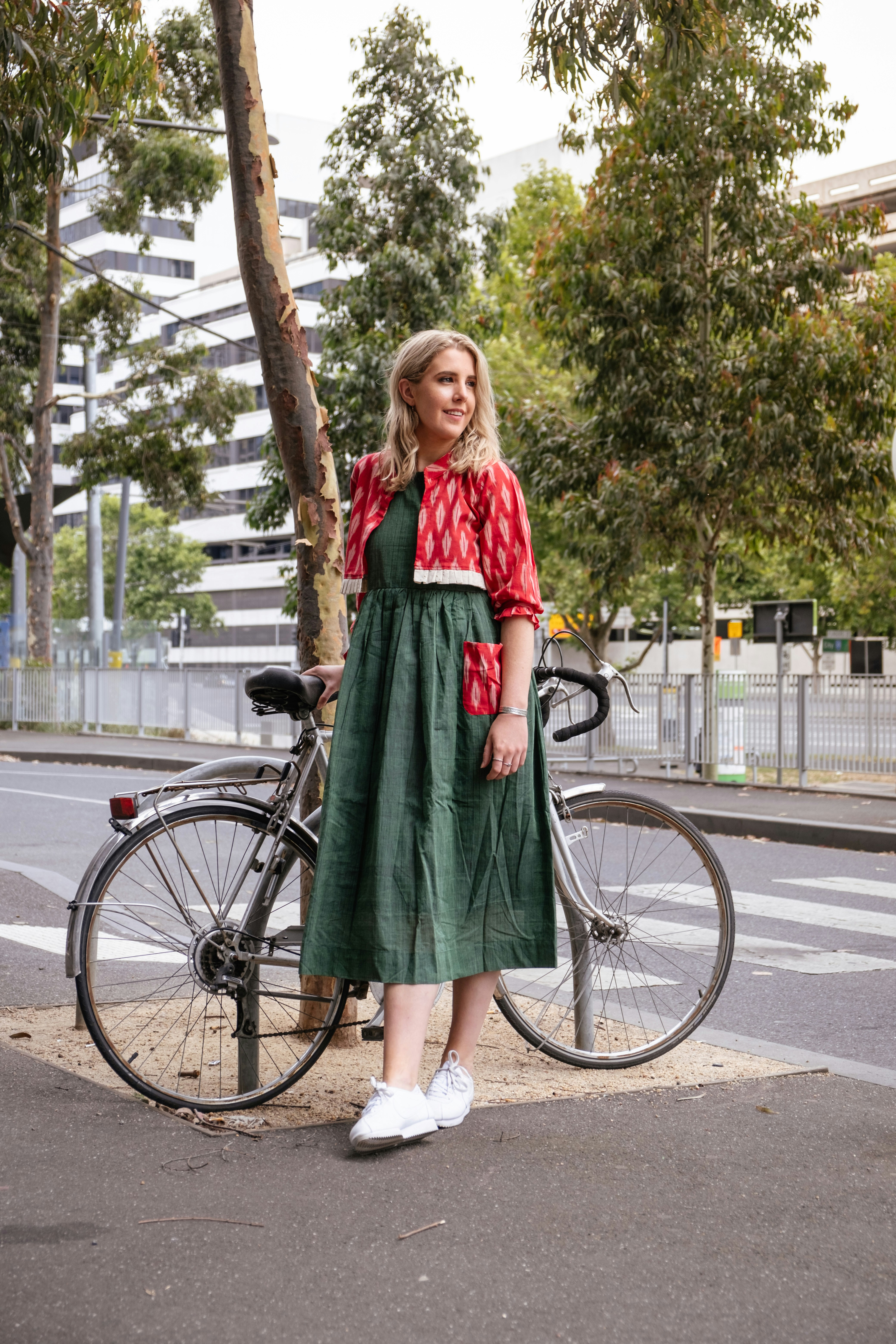 Woman in red and green dress standing on road bike during daytime photo ...