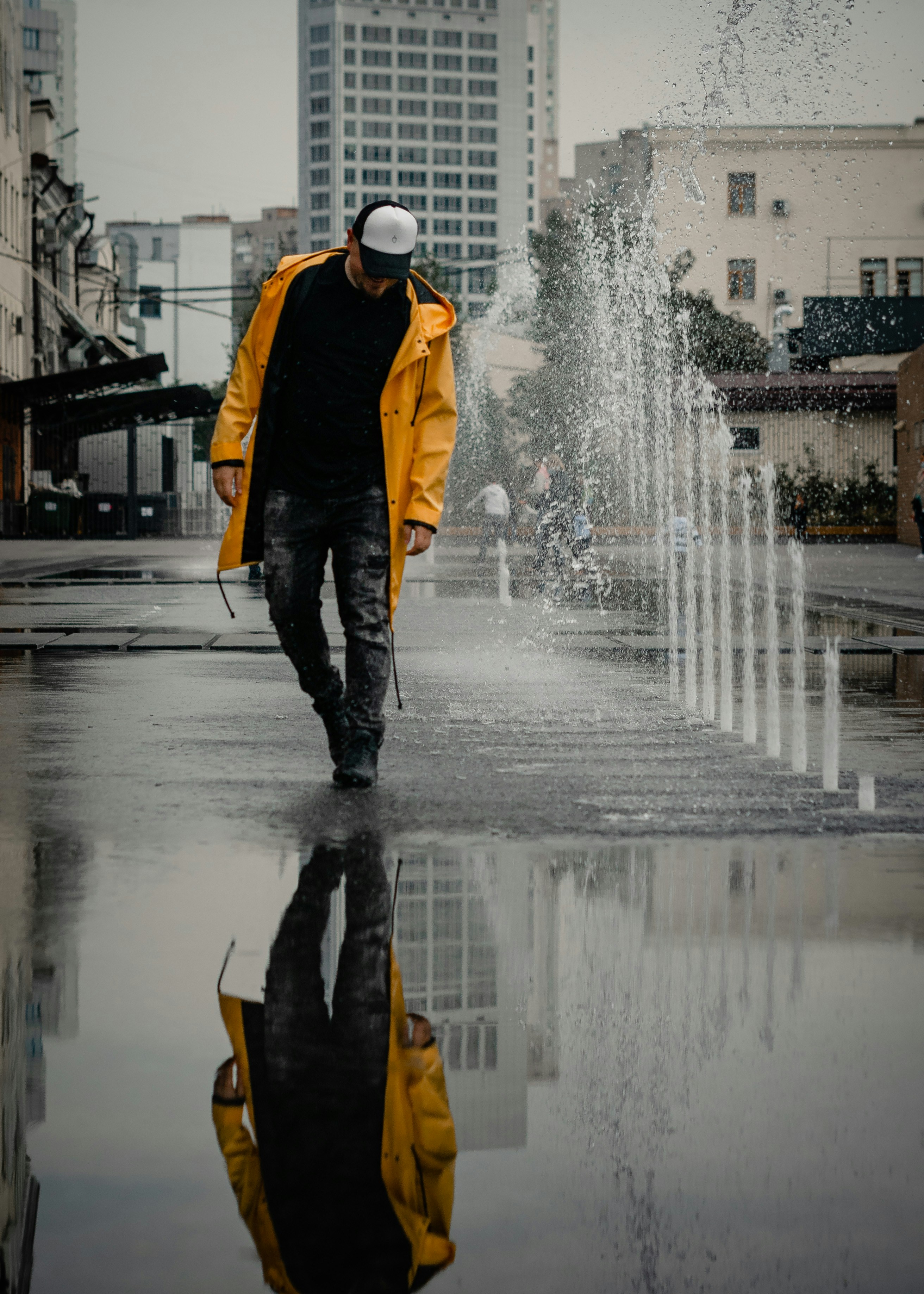 Rainy day and boy in the yellow raincoat 