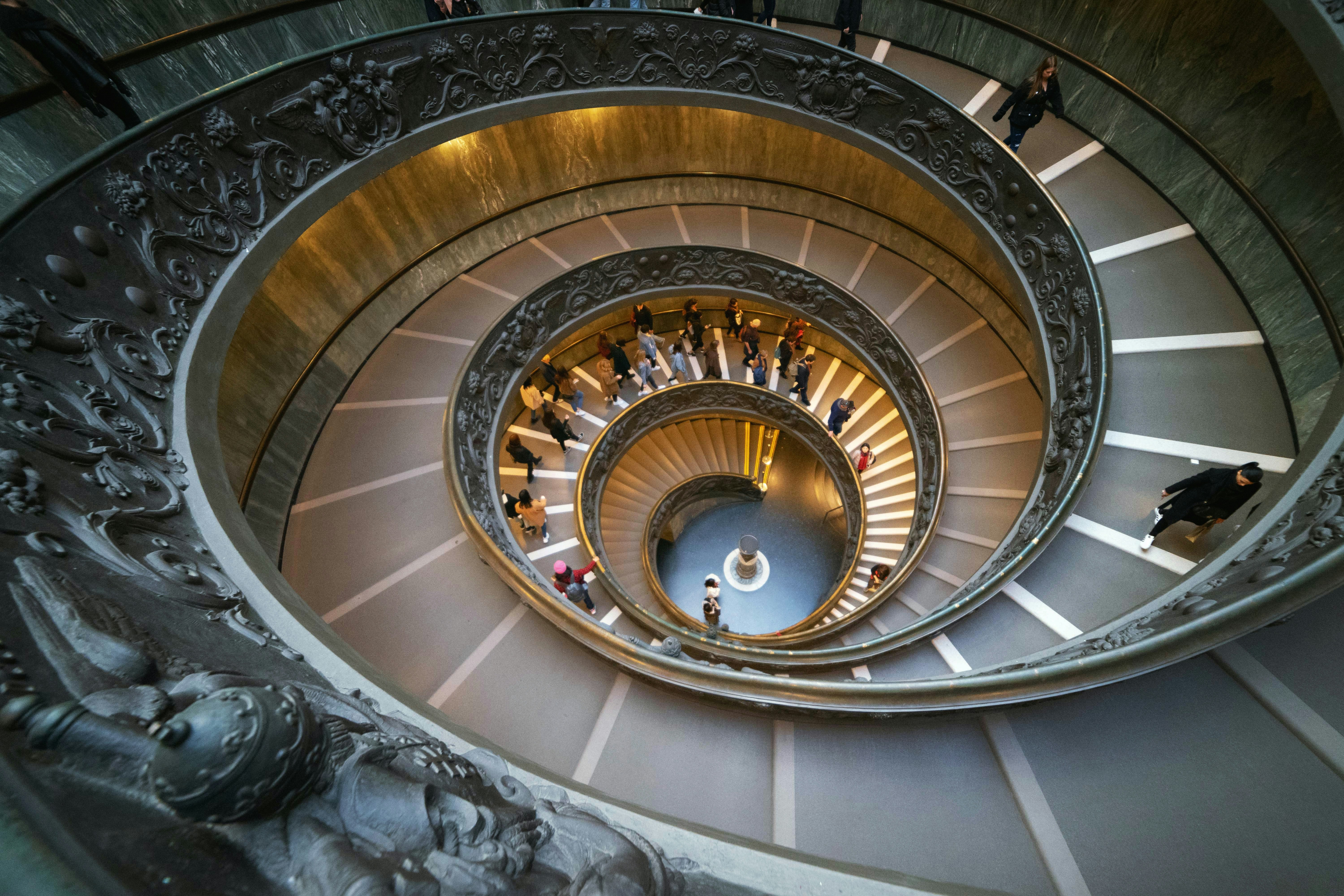 brown spiral staircase with white wooden railings
