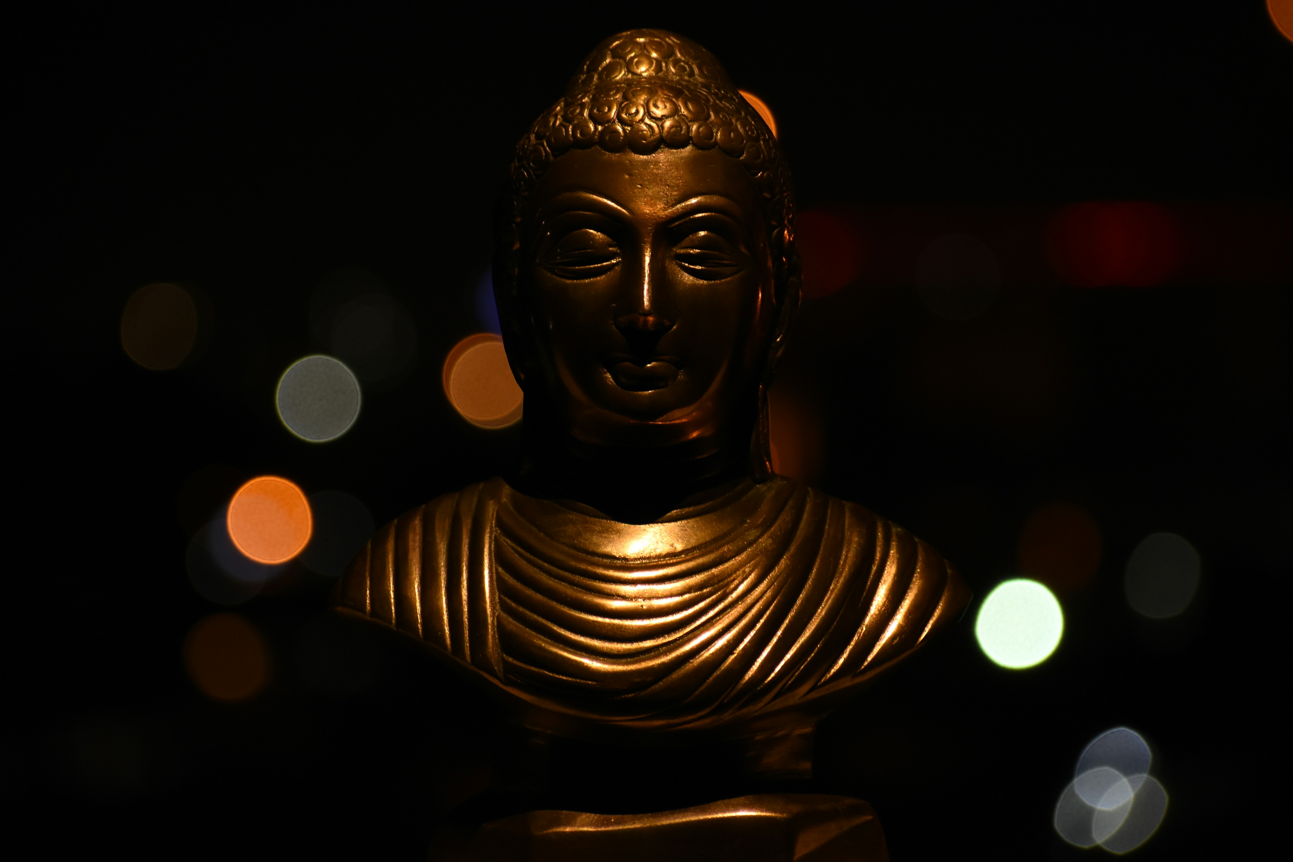 Golden Buddha at Night: Quiet Prominence Amid City Lights